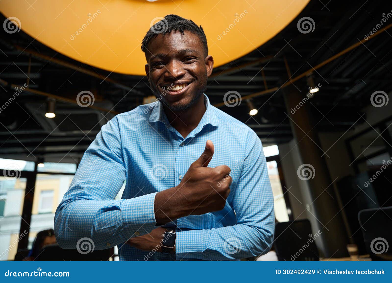 Happy African American Man Showing Thumbs Up And Laughing Looking At