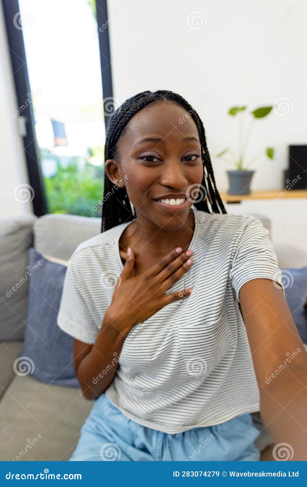 Happy African American Woman Sitting On Sofa And Having Video Call