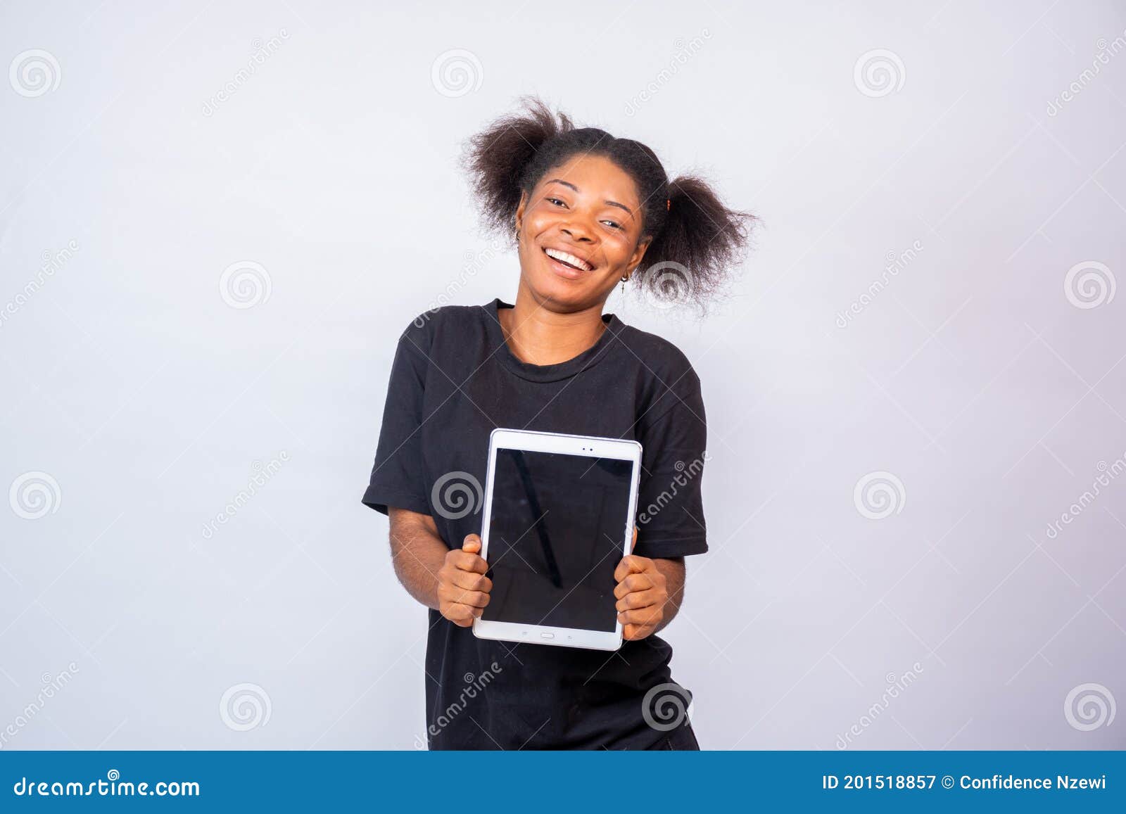 Happy African Lady Holding a Tablet Computer with the Screen Facing ...