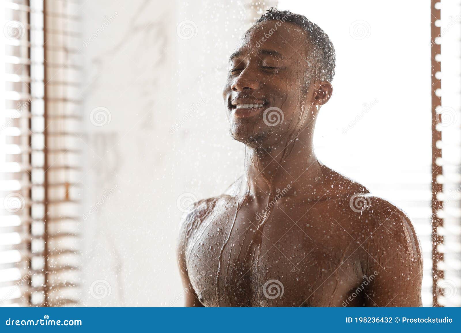 Happy African Man Taking Cold Shower Refreshing In Morning Indoor Stock
