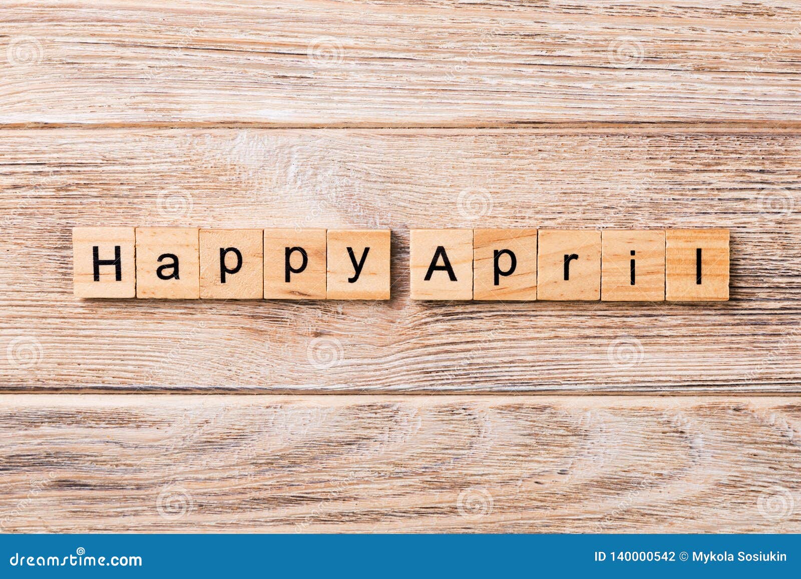 Happy April Word Written on Wood Block. Happy April Text on Table ...