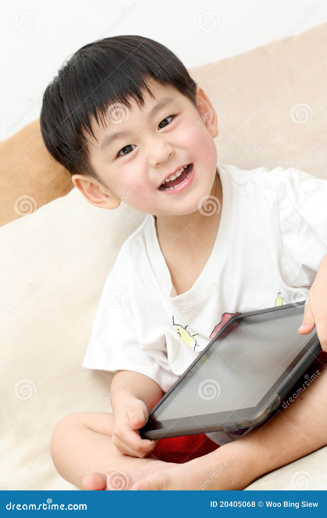 Happy Asian boy with Ipad stock photo. Image of holding - 20405068
