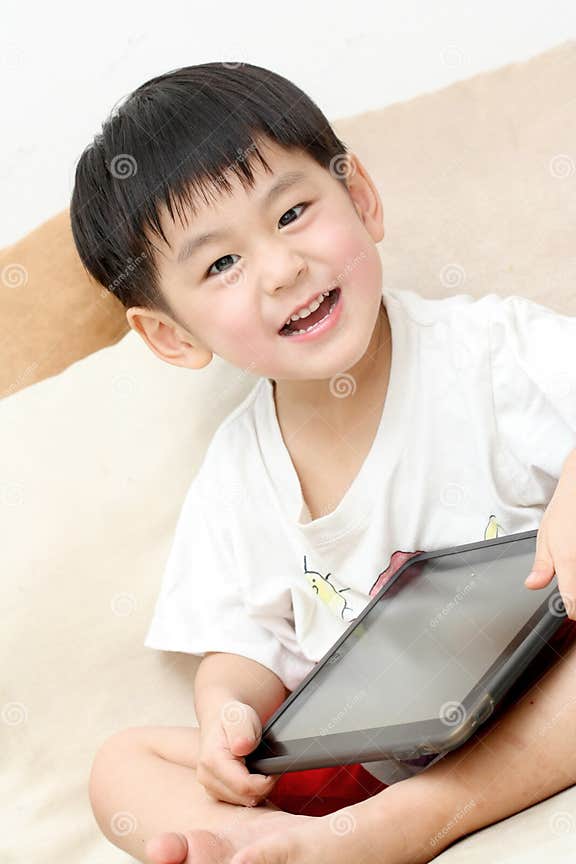 Happy Asian boy with Ipad stock photo. Image of holding - 20405068