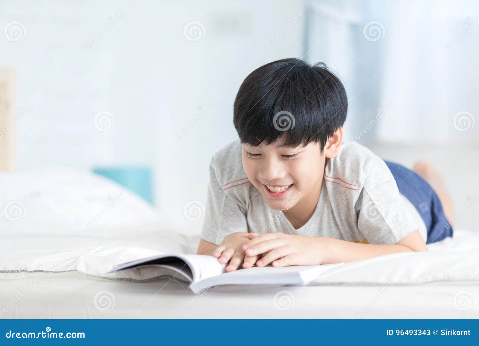 Happy Asian Boy Reading Story Book on the Bed Stock Image - Image of ...
