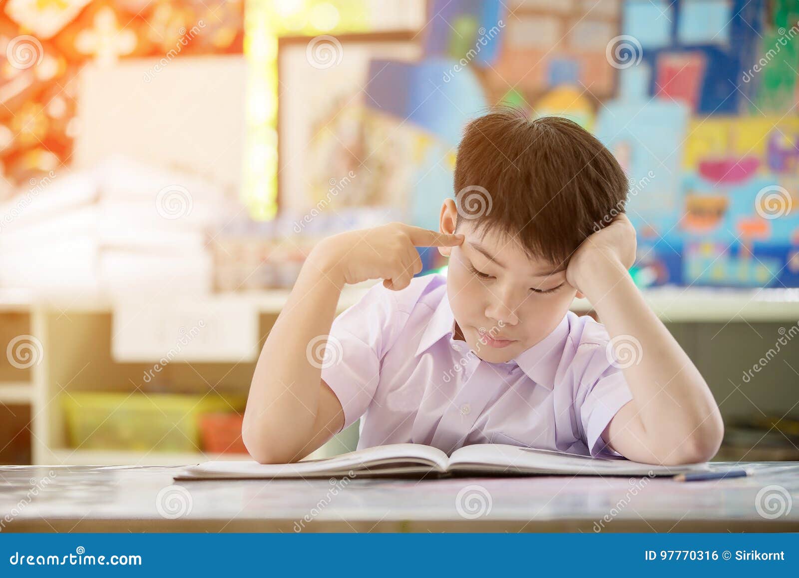 Happy Asian Child Reading Book and Think about that Stock Photo - Image ...