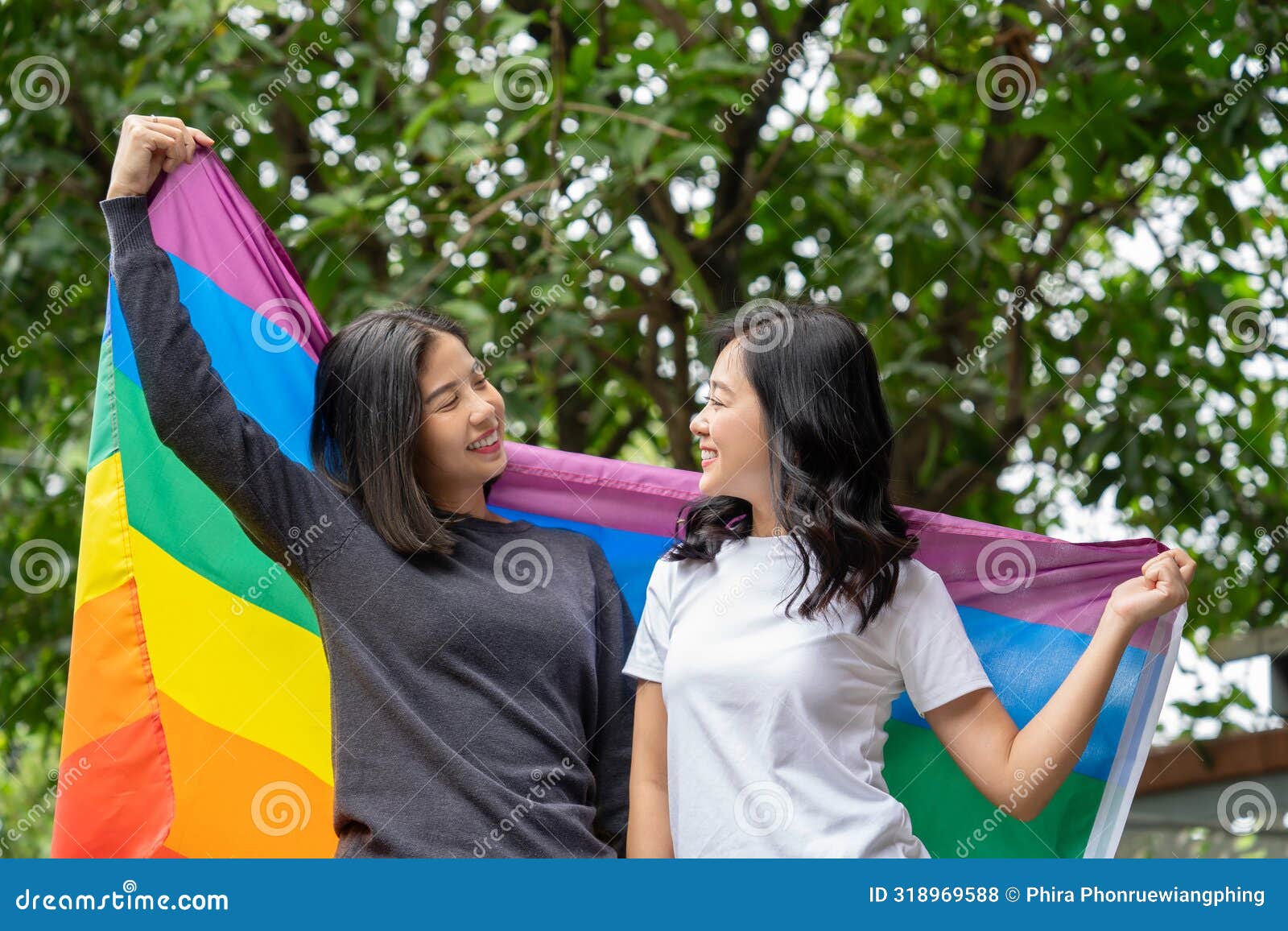 Happy Asian Lesbian Couple with Rainbow Flags in the Park Stock Photo ...