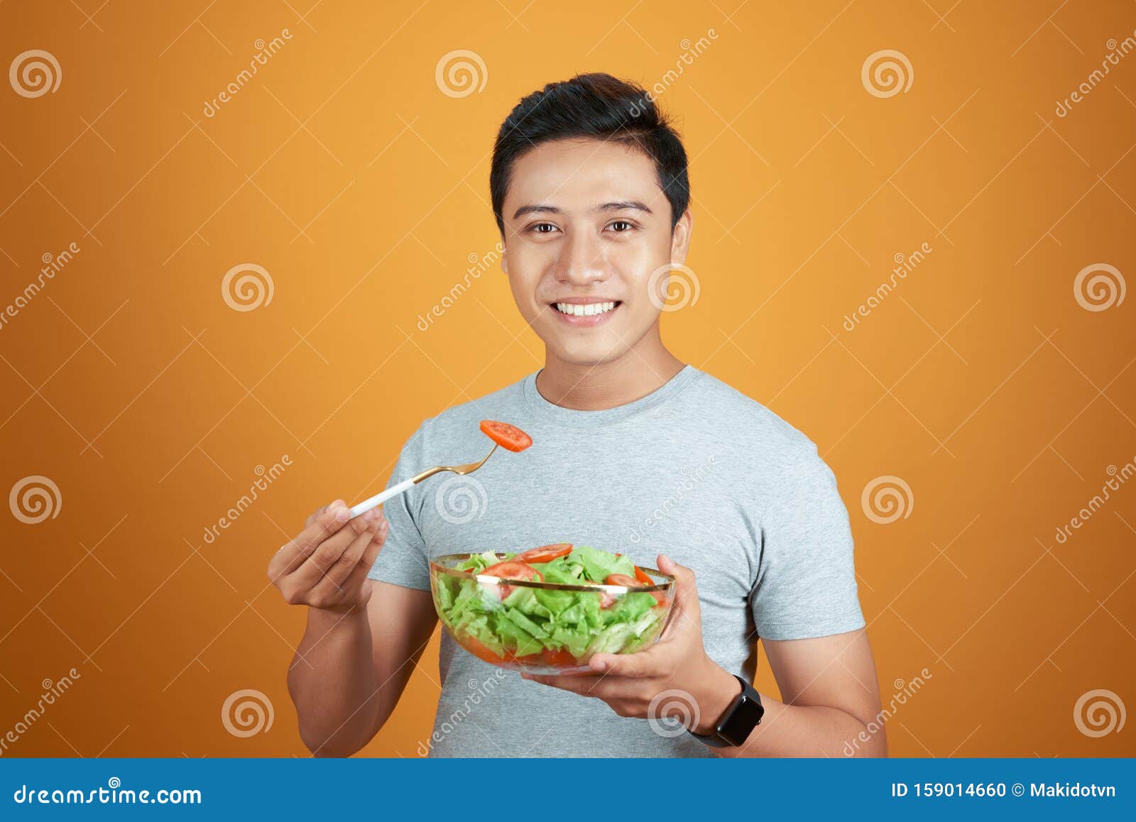 Happy Asian Man Eating Fresh Vegetable Salad Isolated on Oange ... Happy Asian Man Eating Fresh Vegetable Salad Isolated on Oange ...