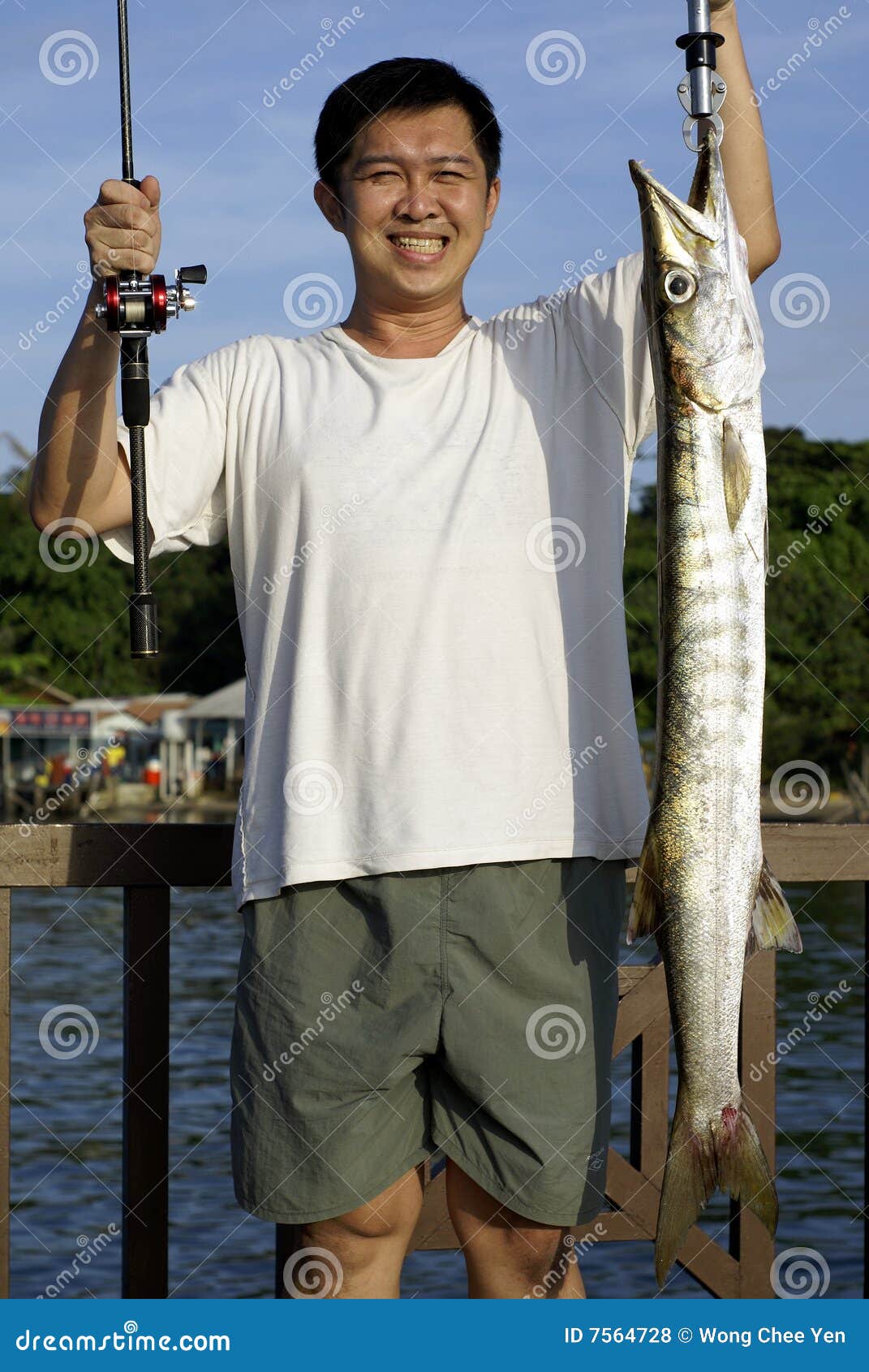 Happy asian man with fish stock photo. Image of outdoors - 7564728