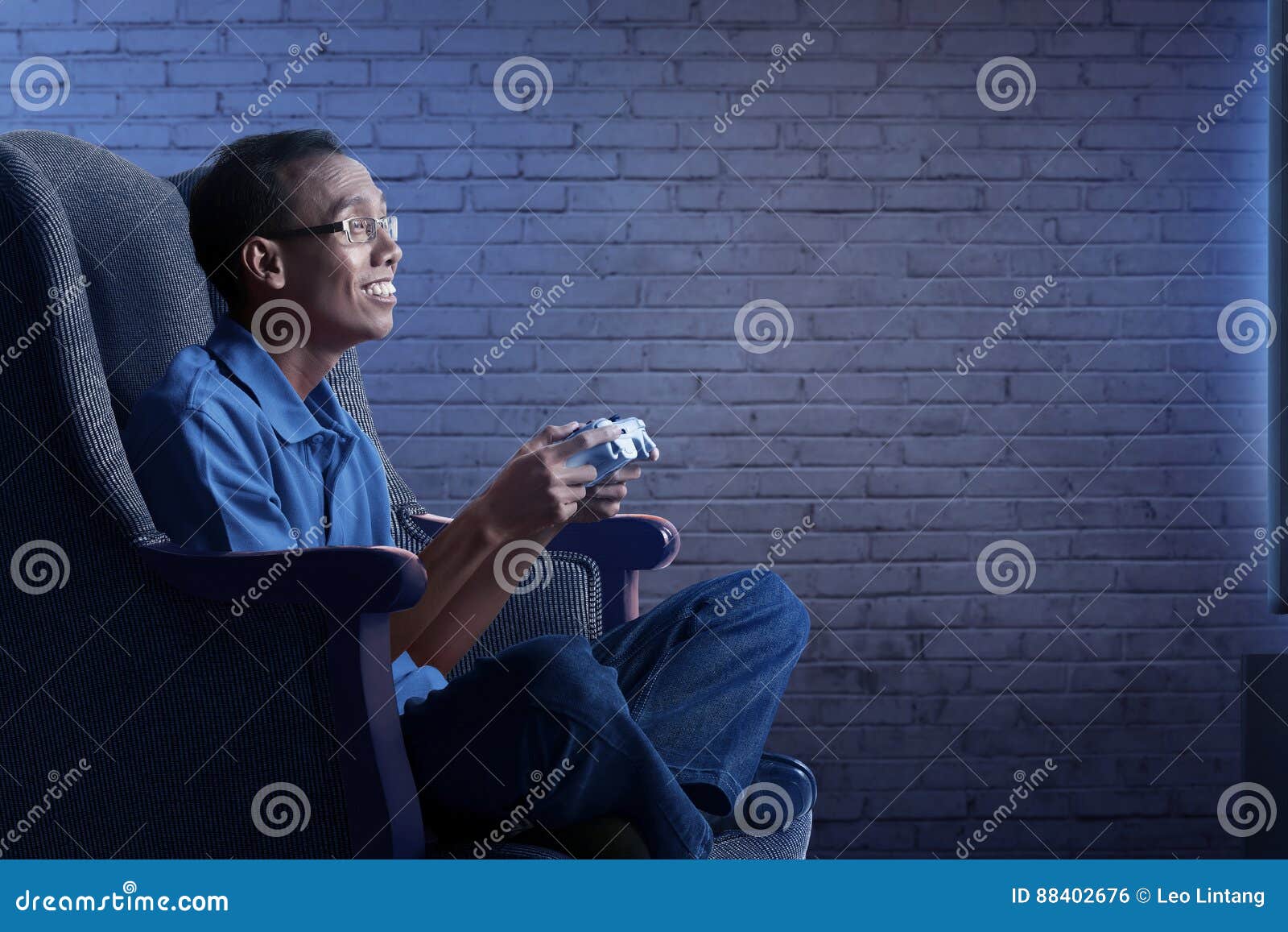Happy Asian Nerd Man in Sofa with Gamepad Playing Game Stock Photo ...