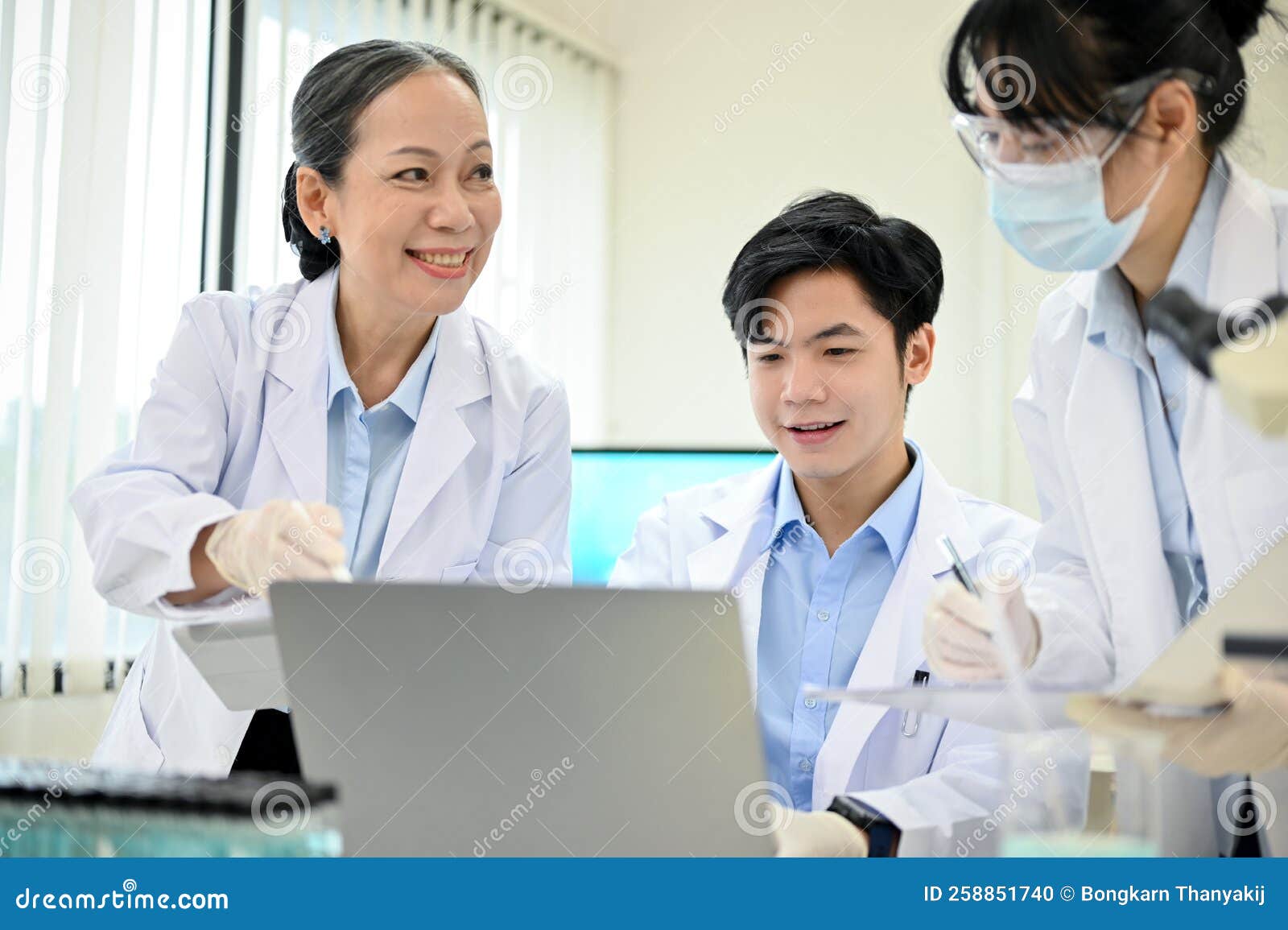 A Happy Asian Scientist Team is Working Together in the Lab, Discussing ... A Happy Asian Scientist Team is Working Together in the Lab, Discussing ...