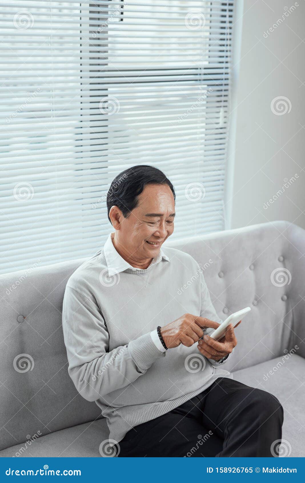 Happy Asian Senior Man Using the Mobile Phone at Home Stock Image ...