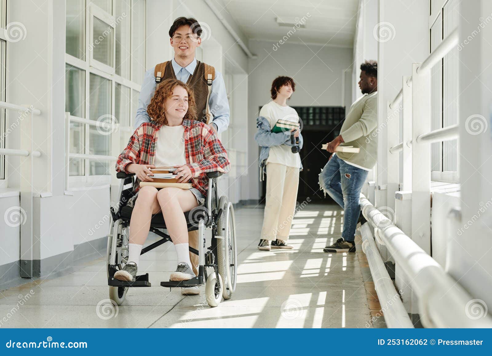 Happy Asian Teenager Pushing His Girlfriend in Wheelchair Along College ... Happy Asian Teenager Pushing His Girlfriend in Wheelchair Along College ...