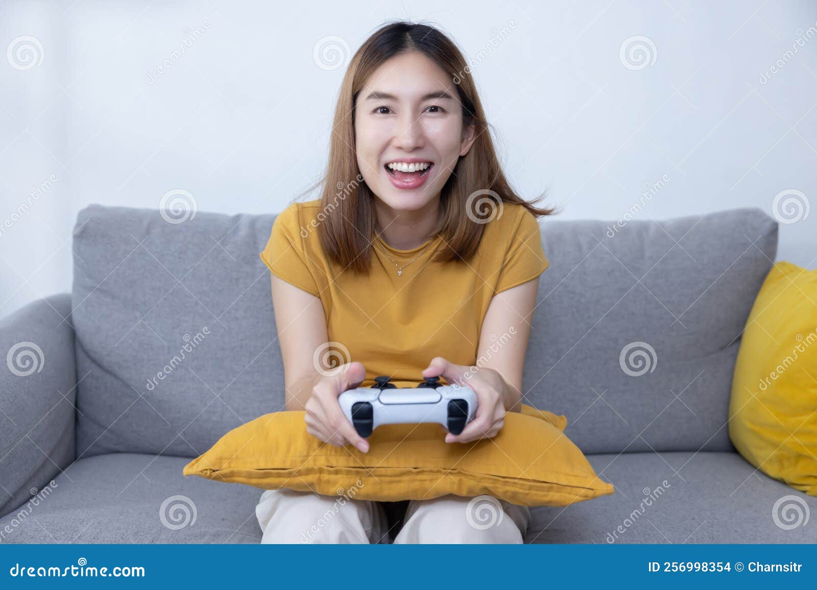 Asian Woman Play Console Game with a Game Controller on Sofa Stock ...