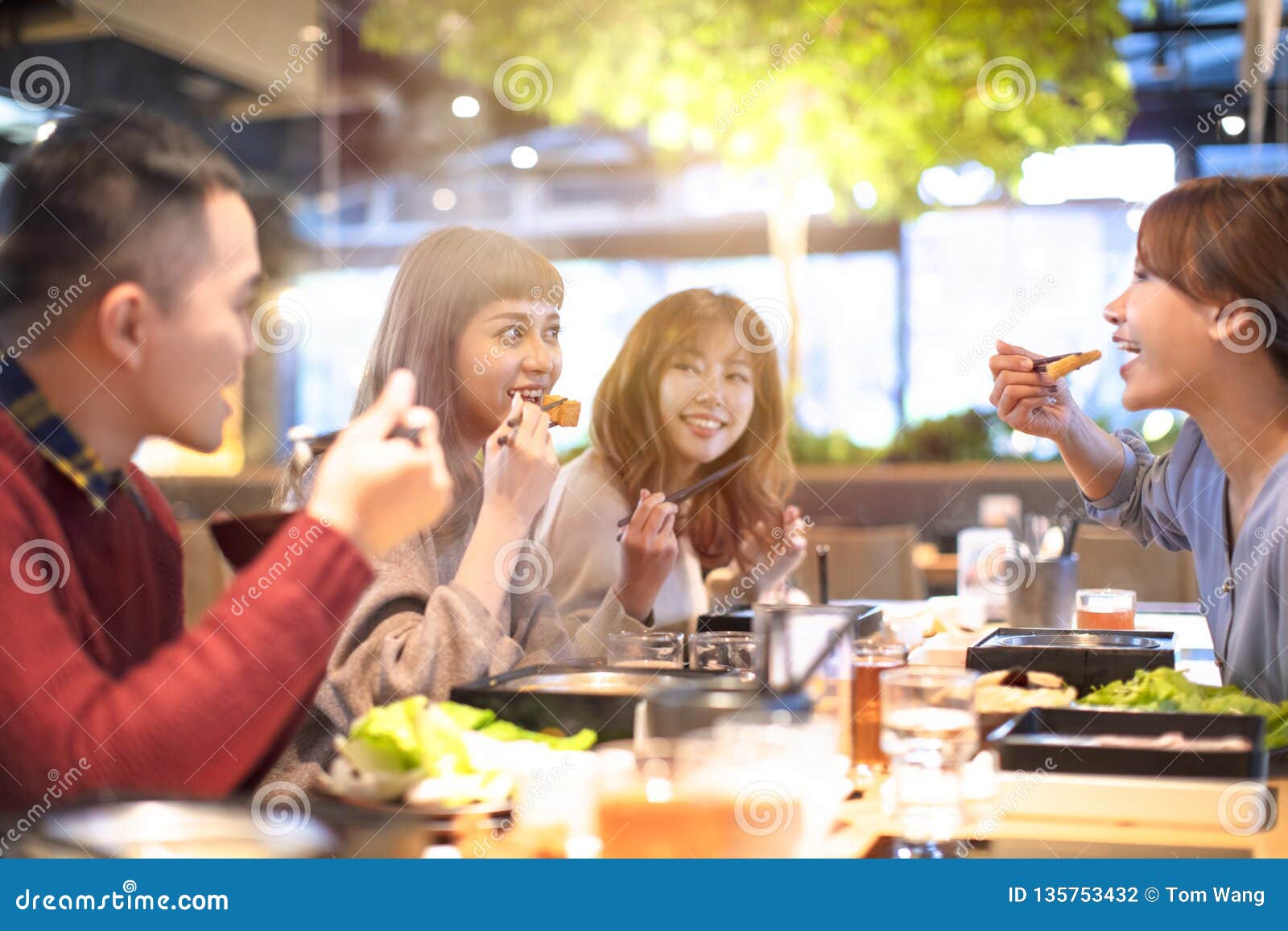 Happy Young Group Eating in the Restaurant Stock Photo - Image of ...