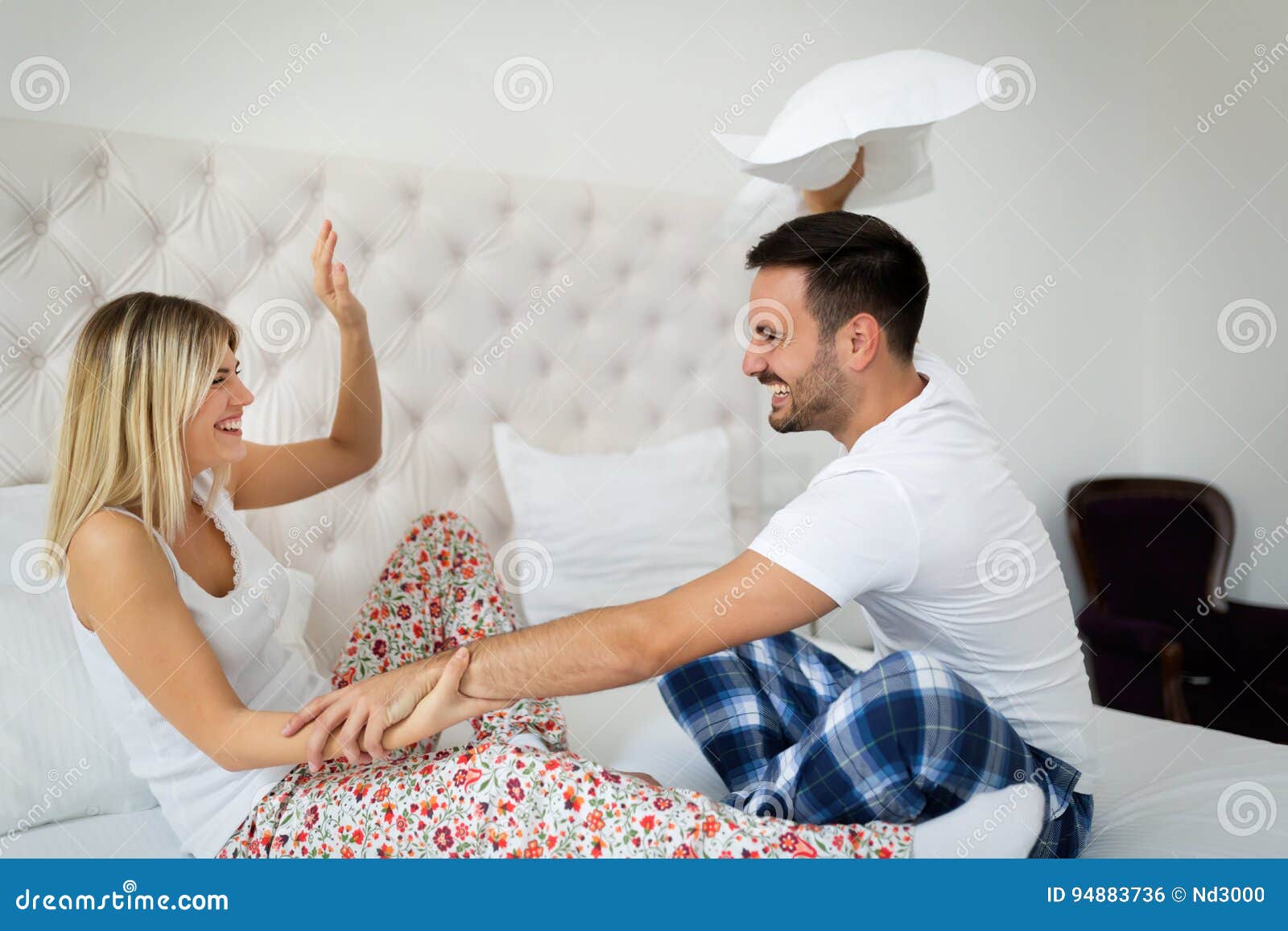 Happy Attractive Couple Play Fighting with Pillows Stock Photo - Image ...