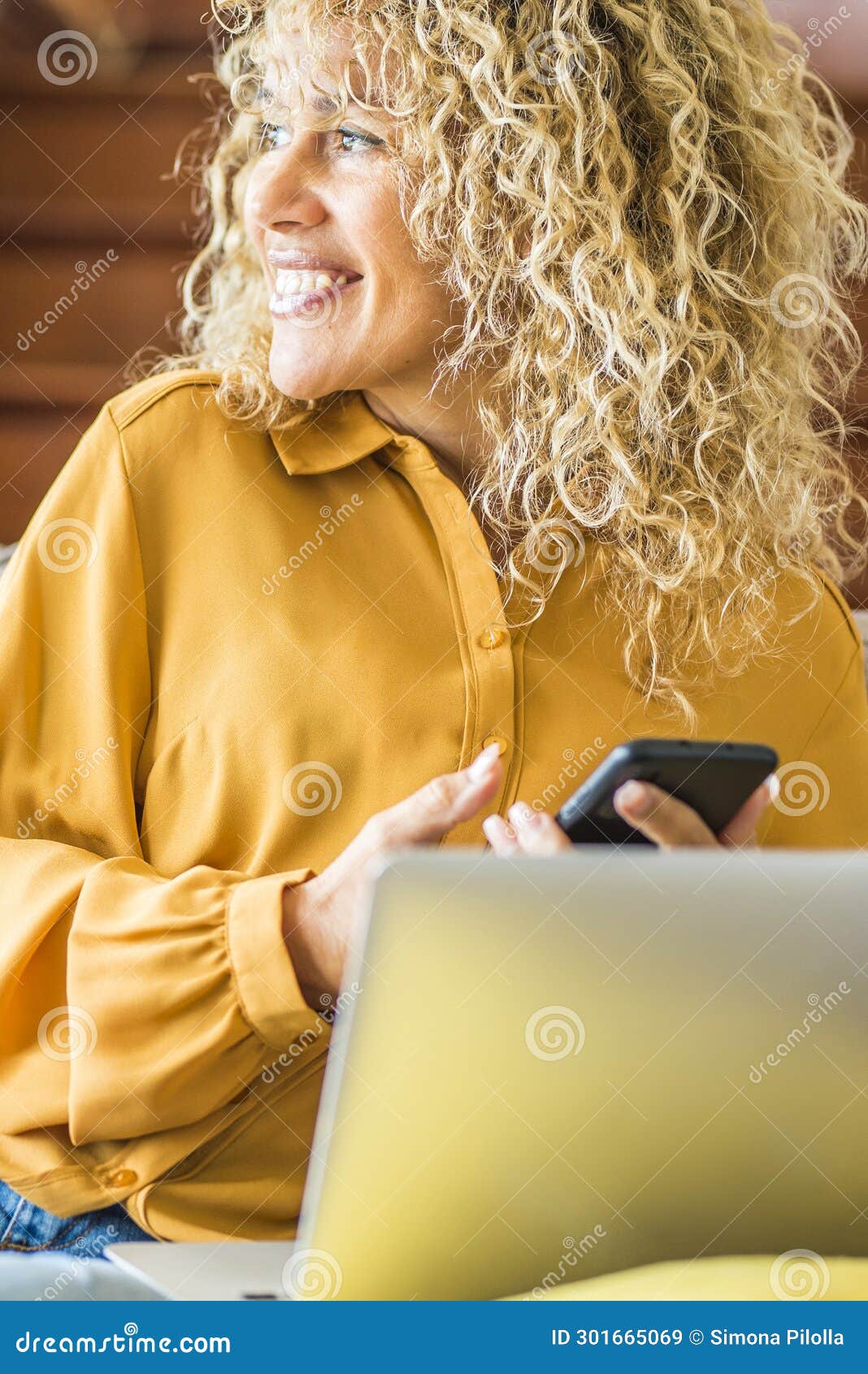 Happy Attractive Woman Smiling And Using Mobile Phone And Laptop On The Sofa At Home Adult