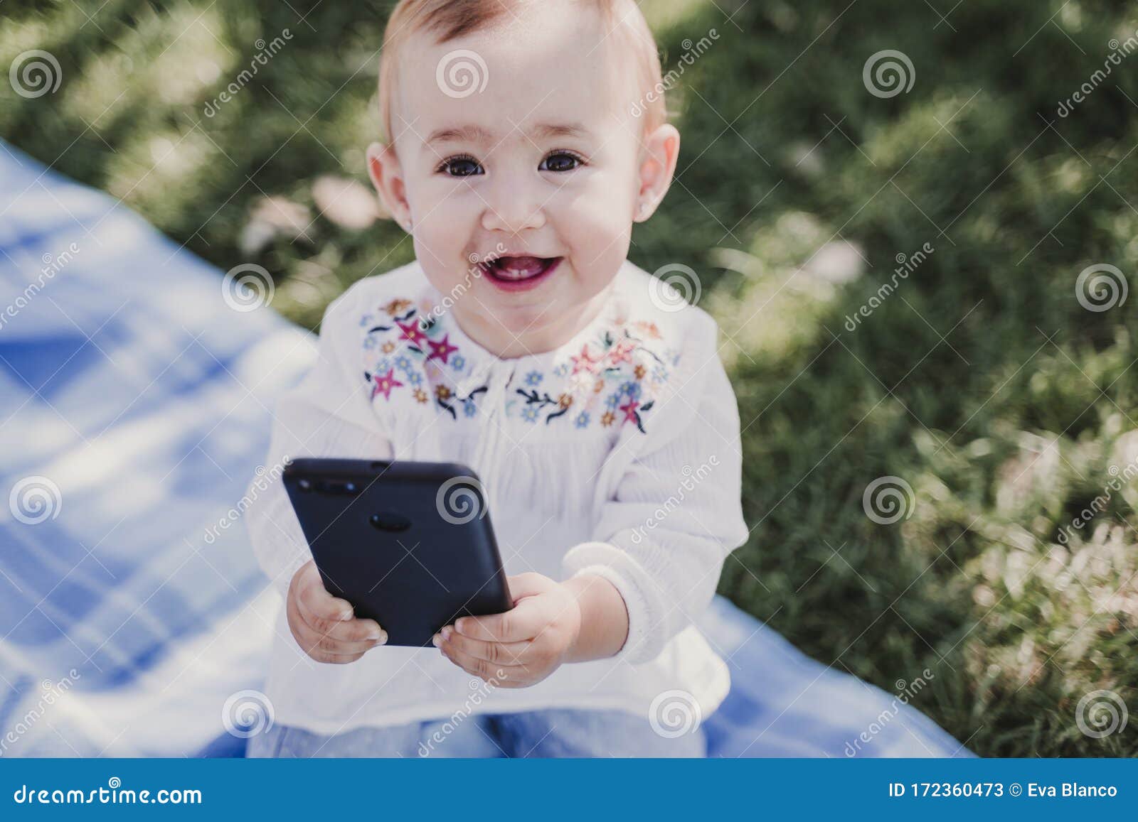 Happy Baby Using Mobile Phone Outdoors. Technology Concept Stock Image ...
