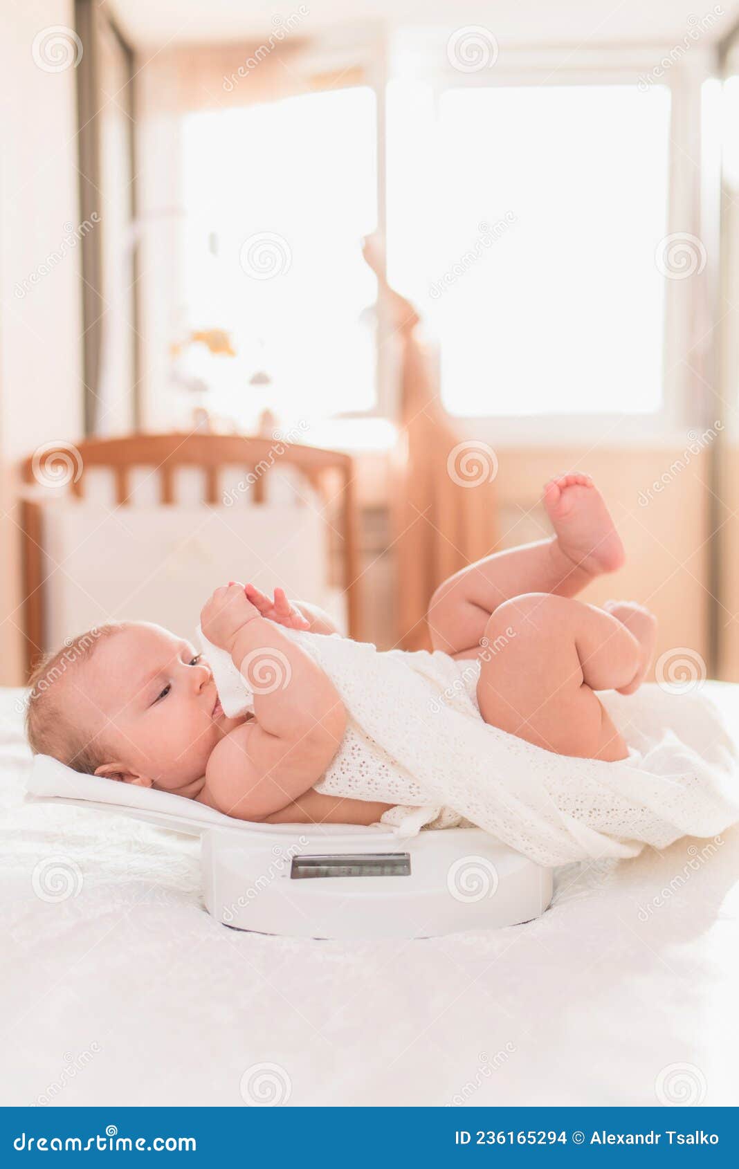 Happy Baby Lying on the Scales in the Bedroom Stock Photo - Image of ...
