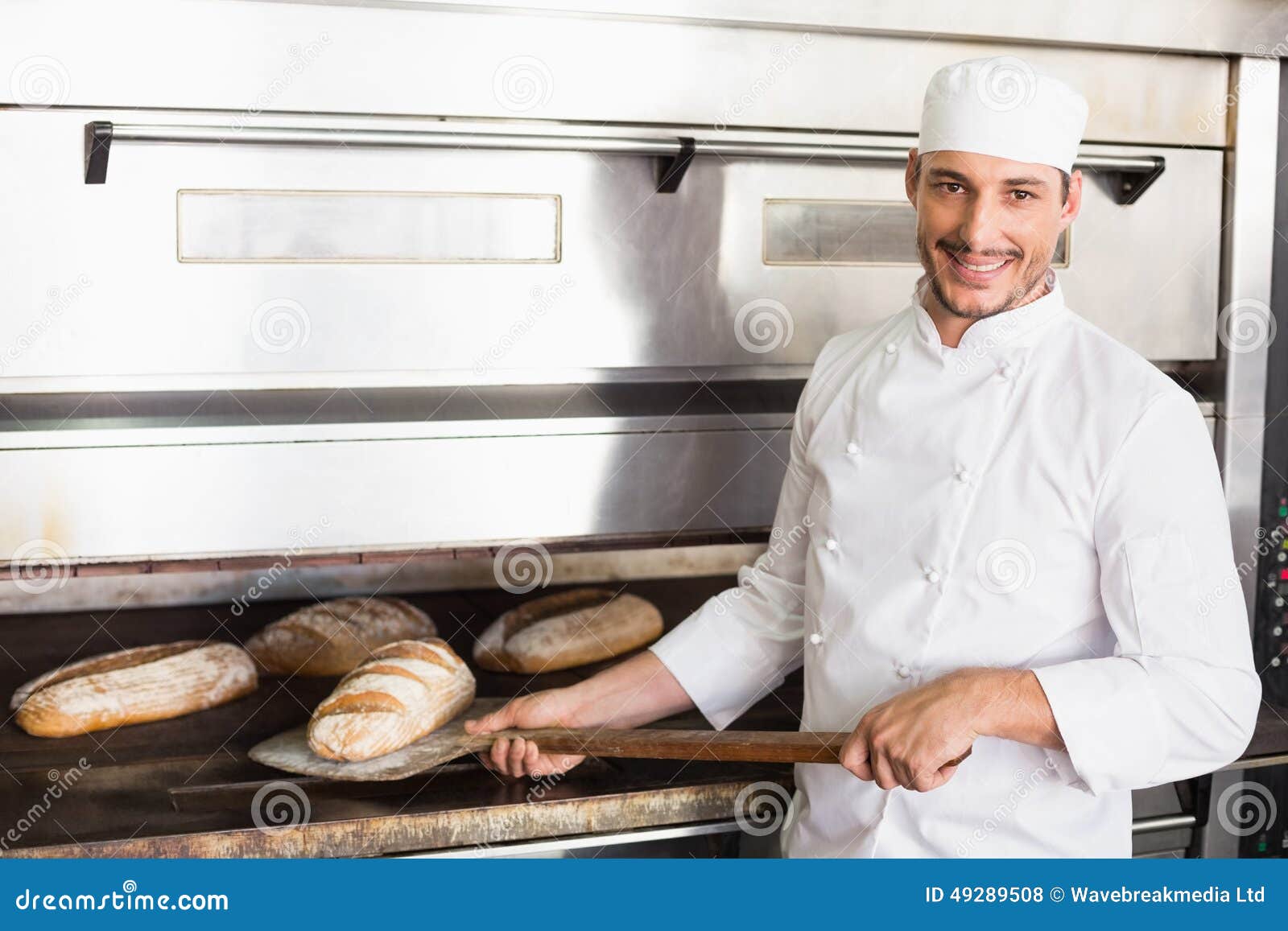 Happy Baker Taking Out Fresh Loaf Stock Photo - Image of bakery, baker ...
