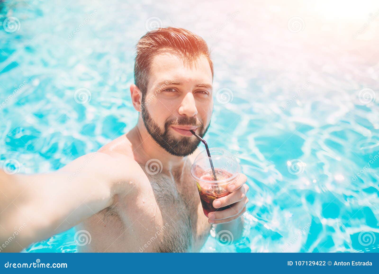 Happy Bearded Man Making Selfie in Swimming Pool. he is Drinking a ... Happy Bearded Man Making Selfie in Swimming Pool. he is Drinking a ...