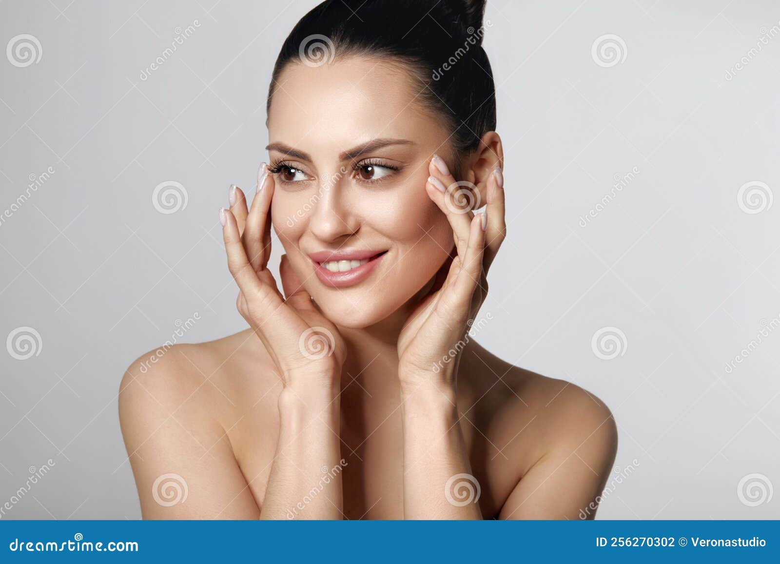 Happy Beautiful Girl Holding Her Cheeks With A Laugh Looking To The