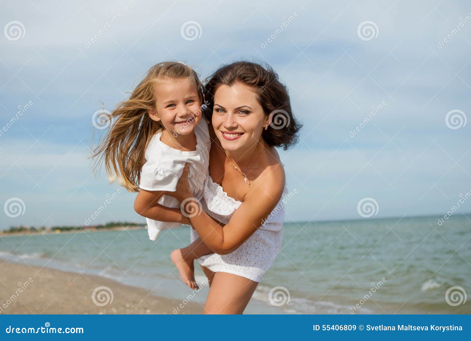 Happy Beautiful Mother And Daughter Enjoying Beach Time Stock Image