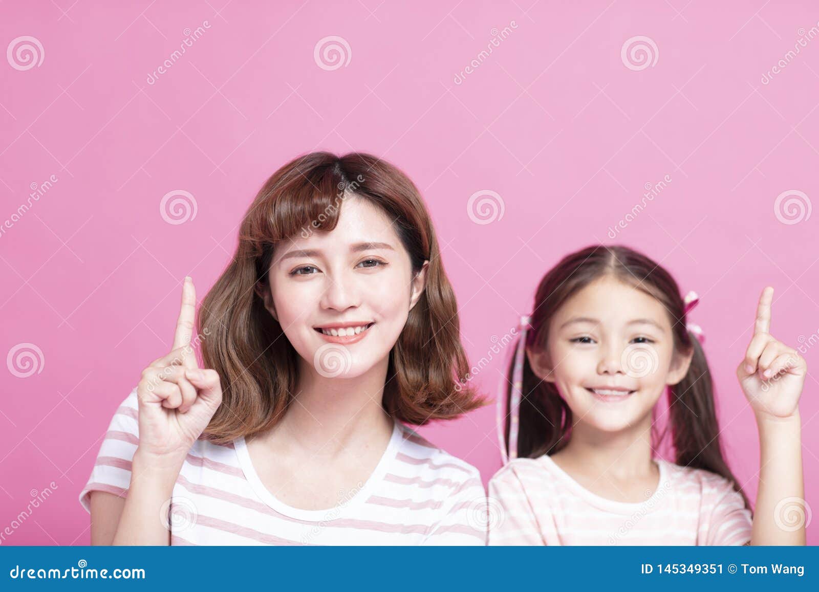 Beautiful Mother and Daughter Pointing Up Stock Image - Image of ...