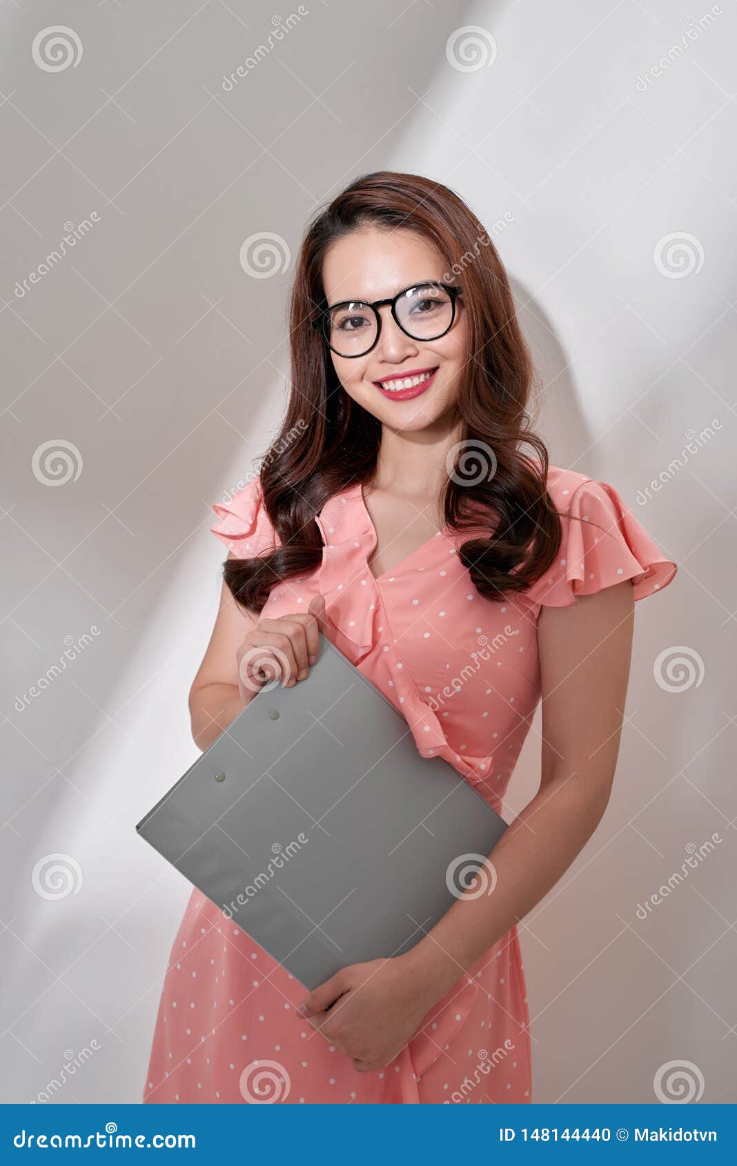 Happy Beautiful Young Business Woman Standing and Holding Clipboard ... Happy Beautiful Young Business Woman Standing and Holding Clipboard ...