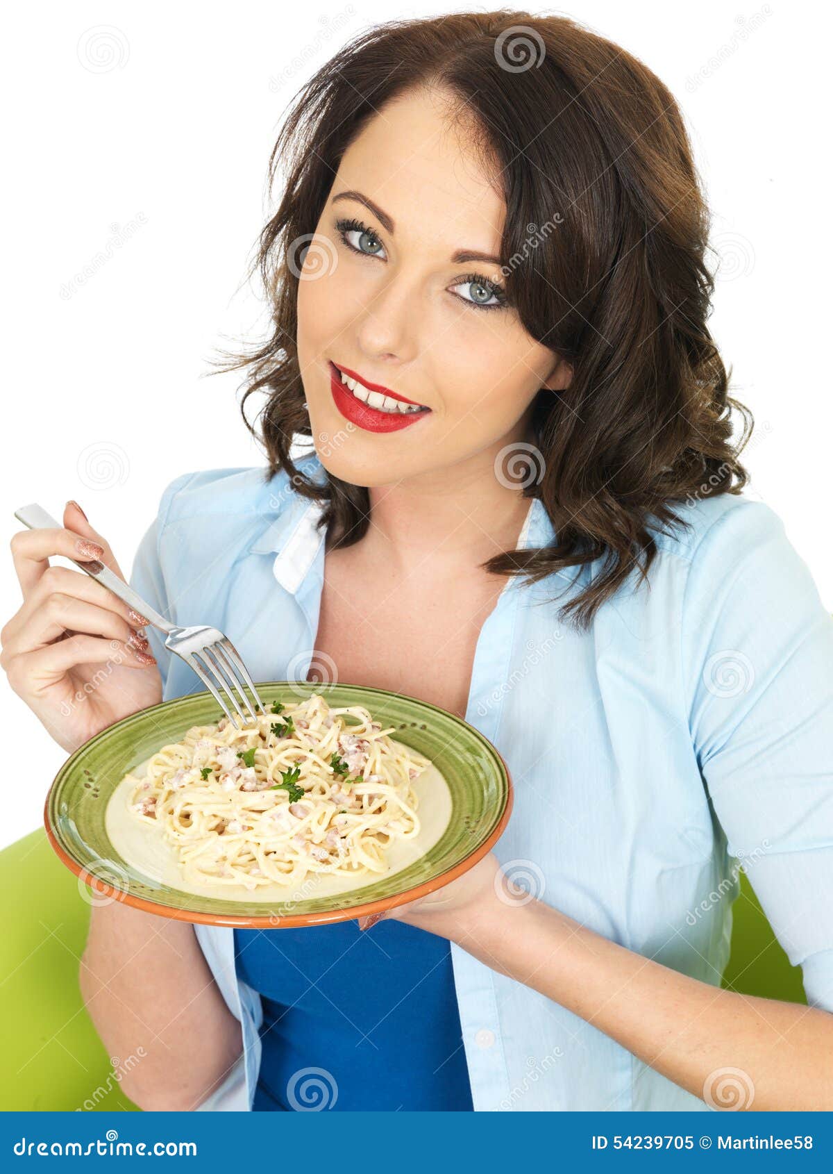 Happy Beautiful Young Woman Eating A Plate Of Spaghetti Carbonara Pasta