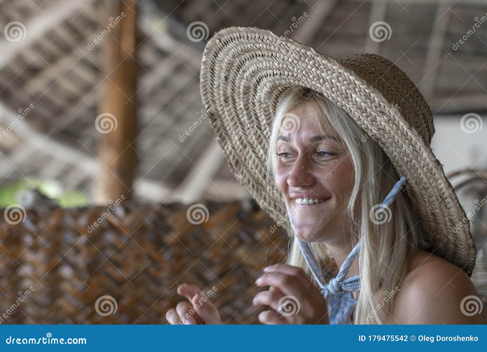 Happy Beautiful Young Woman In A Straw Hat On A Tropical Beach Close