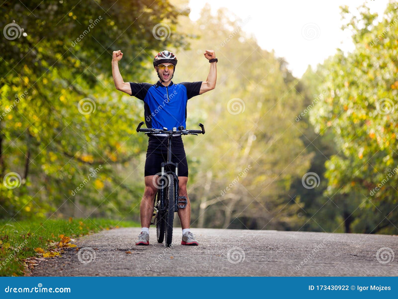 Happy Biker with Raised Hands Stock Photo - Image of happy, green ...