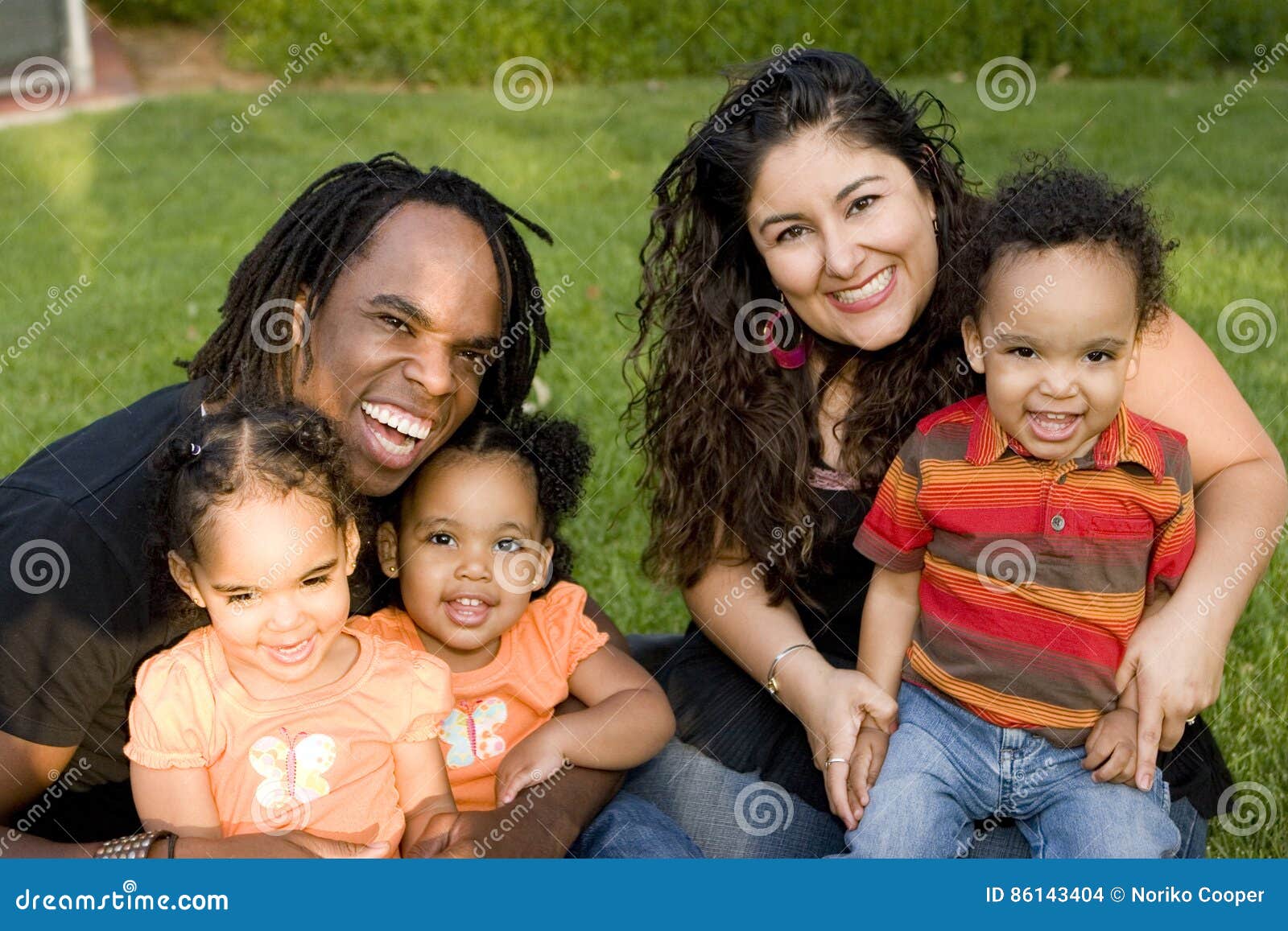 Happy Biracial Family with Triplets at a Park. Stock Photo - Image of ...
