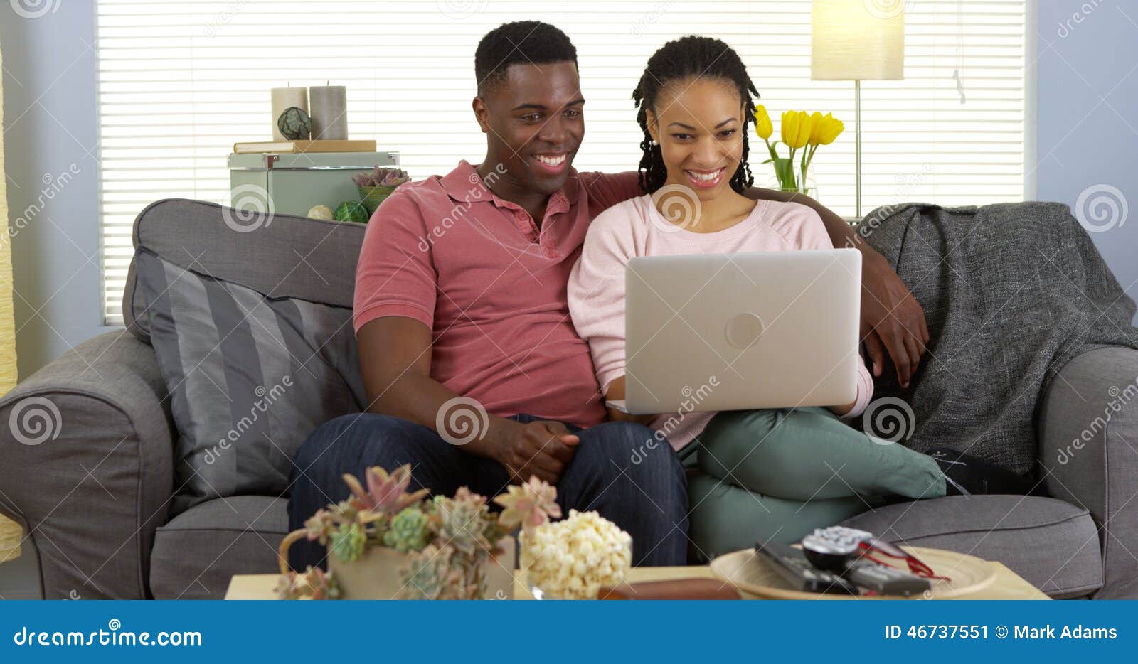Happy Black Couple on Couch Browsing Internet with Laptop Stock Image ...