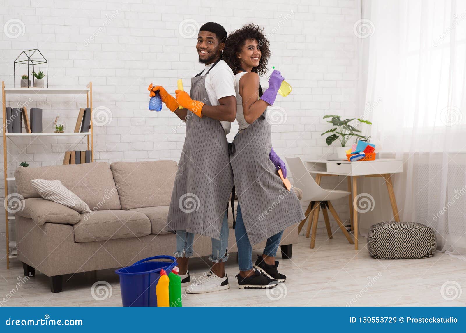 Happy Black Couple Holding Detergents During Cleaning At Home Stock