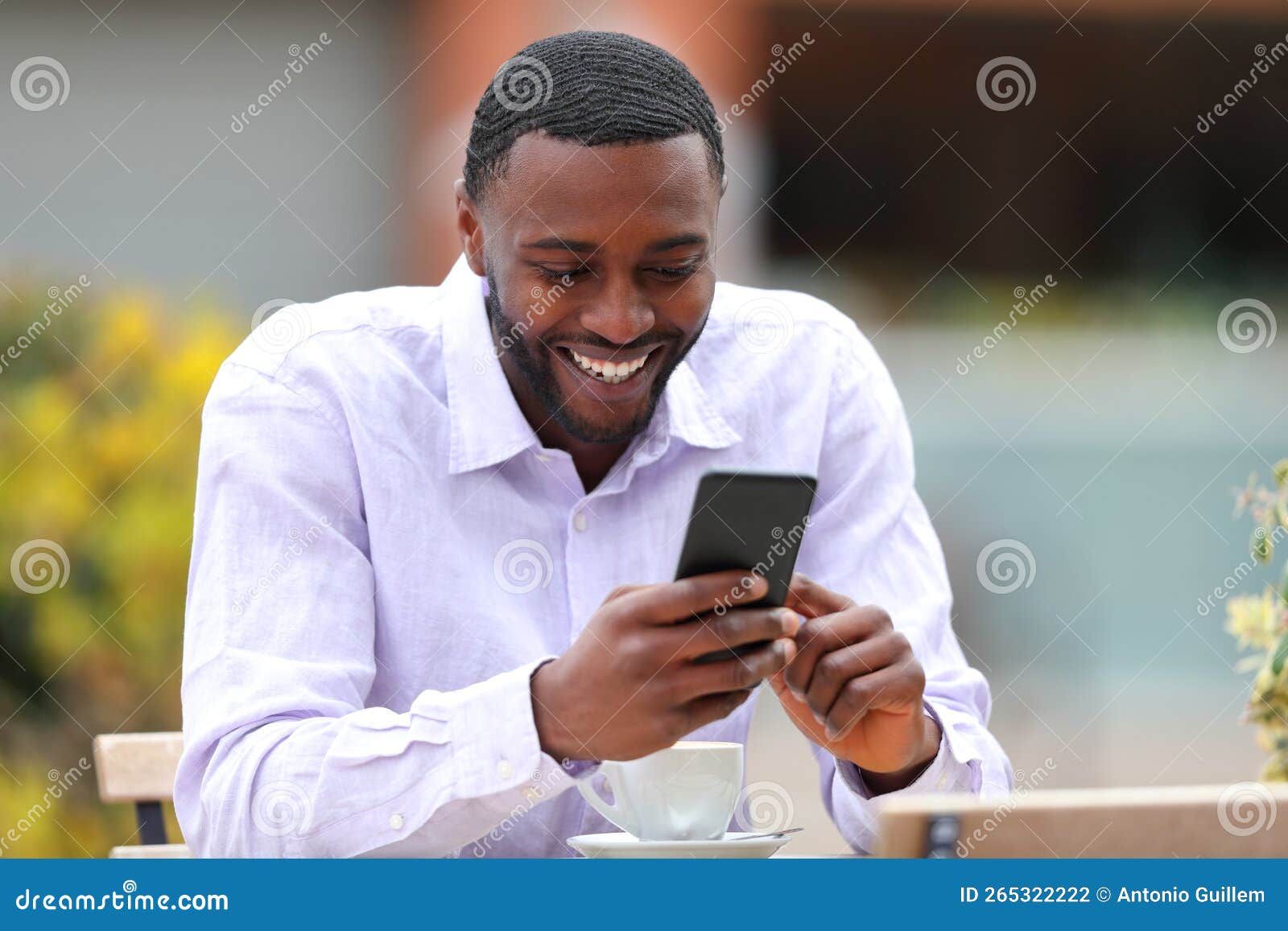 Happy Black Man Checking Mobile Phone in a Bar Stock Photo - Image of ...