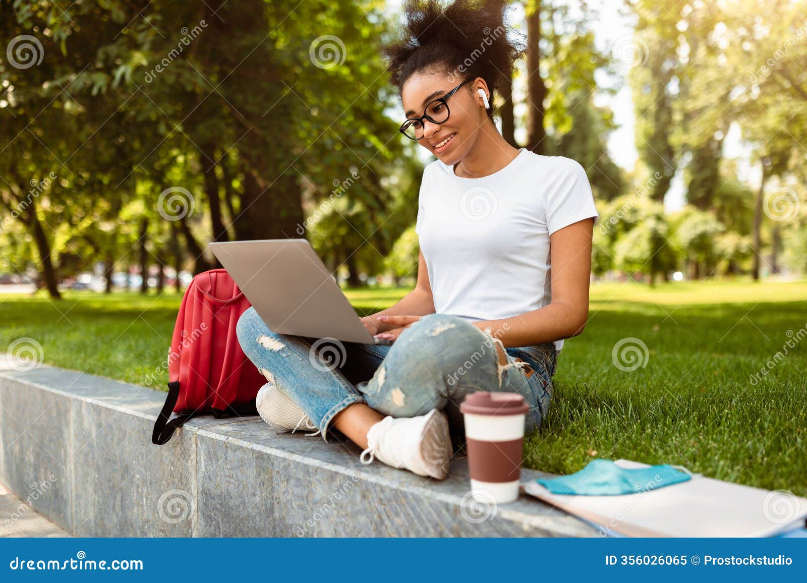 Happy Black Student Watching Lecture on Laptop in Park, Side-View Stock ...