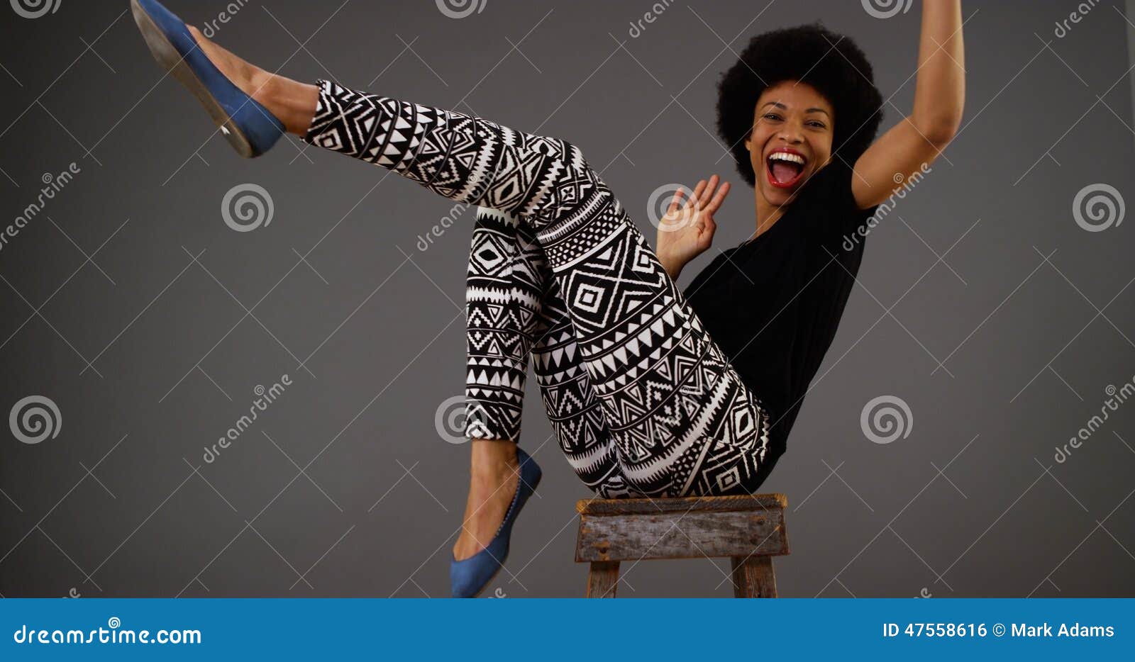 Happy Black Woman Dancing on Chair Stock Photo - Image of arms, copy ...