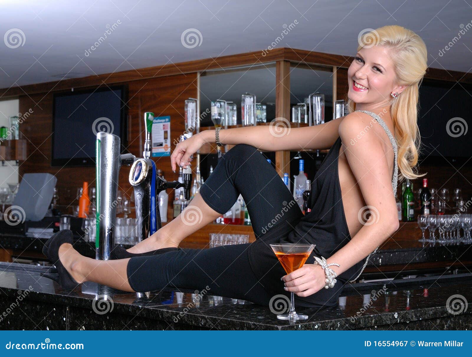 Happy blond woman on bar stock image. Image of nightclub - 16554967