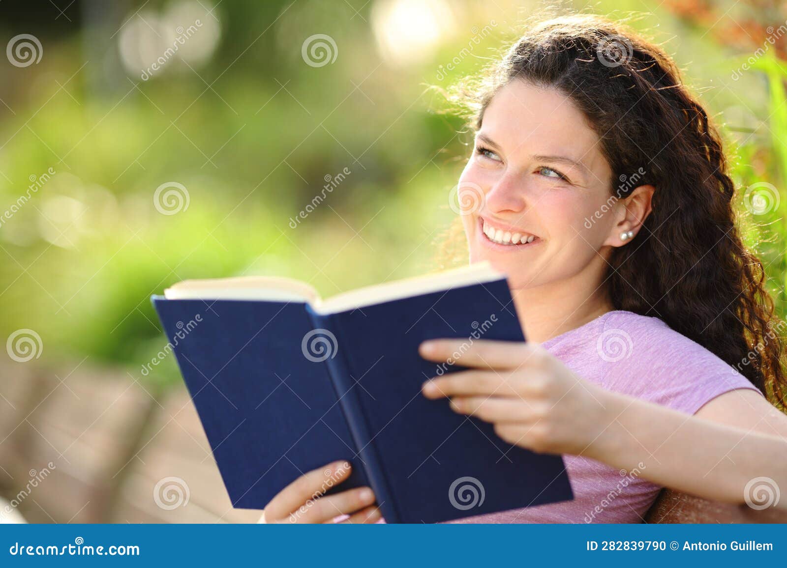 Happy Book Reader Dreaming in a Park Stock Photo - Image of reader ...