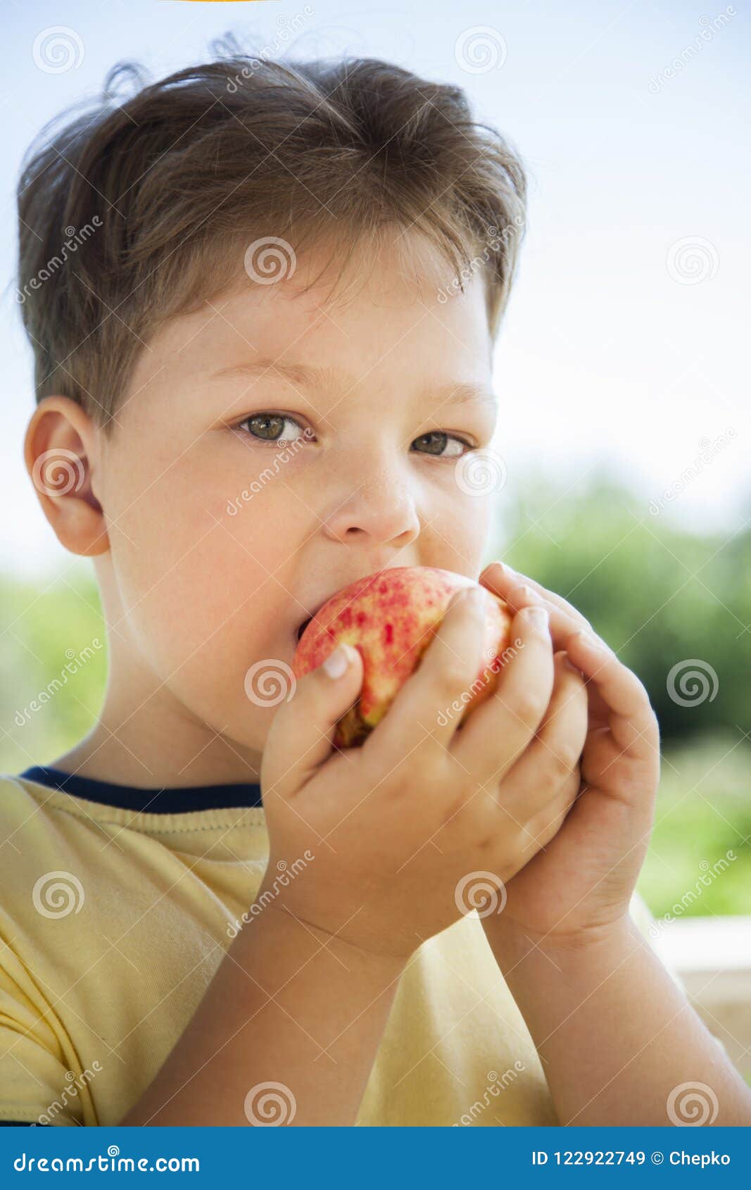 Happy Boy Biting the Apple, a Child with a Fruit. Kid Eating Fresh Pear ...