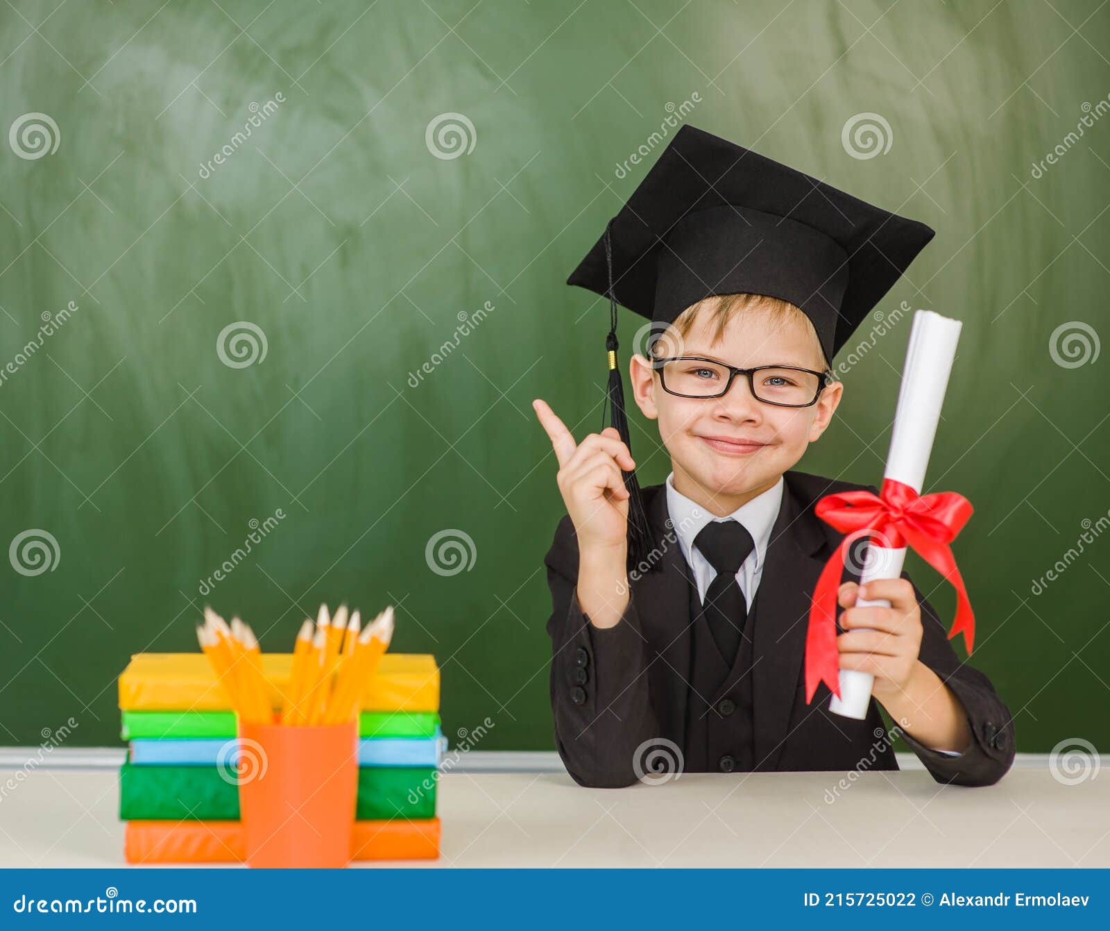 Happy Boy with Diploma in Graduation Hat Points on Empty Green ...
