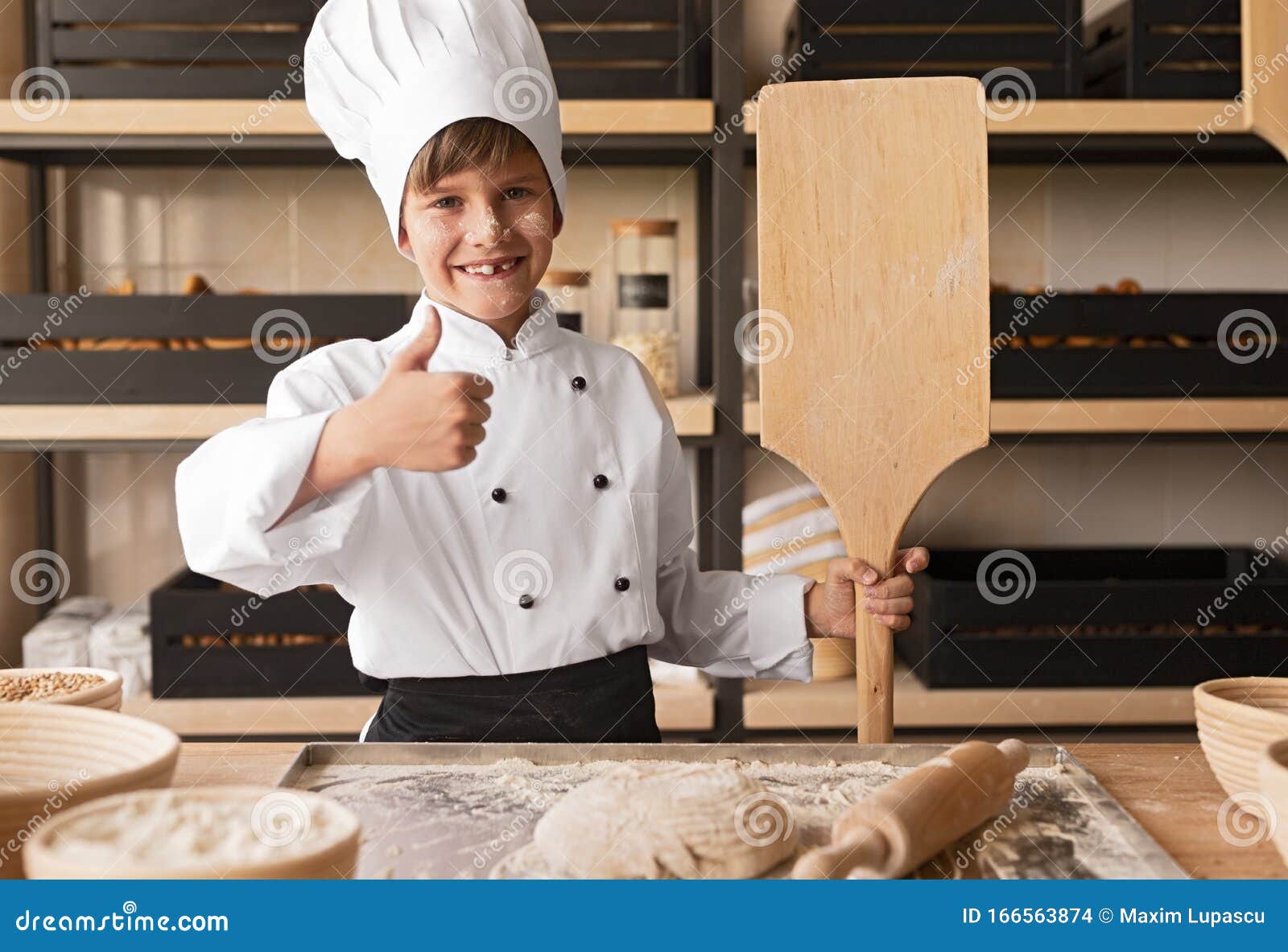 Baker Apprentice Gesturing Thumb Up Stock Photo - Image of cook, flour ...
