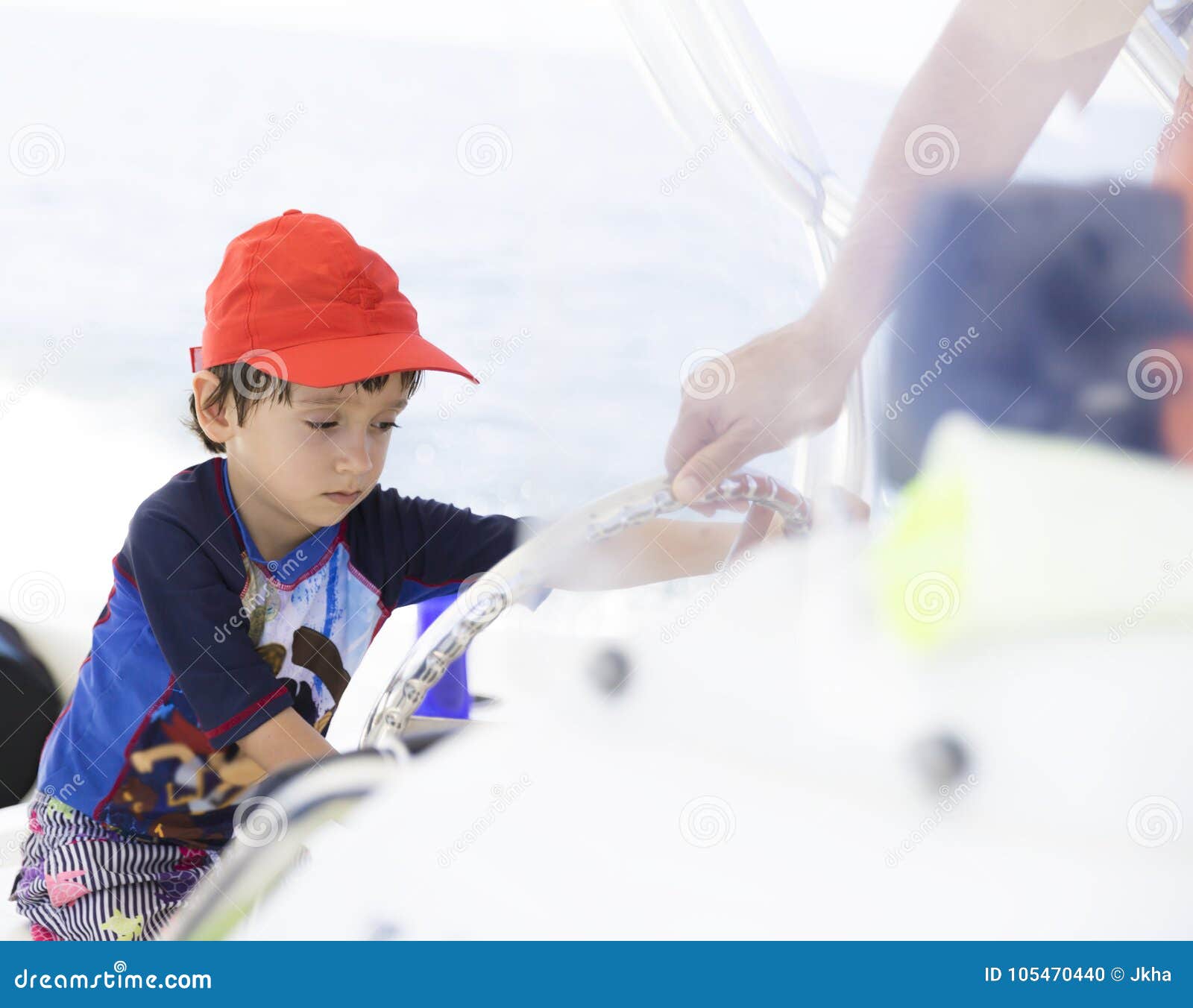 Happy boy driving a boat stock photo. Image of human - 105470440
