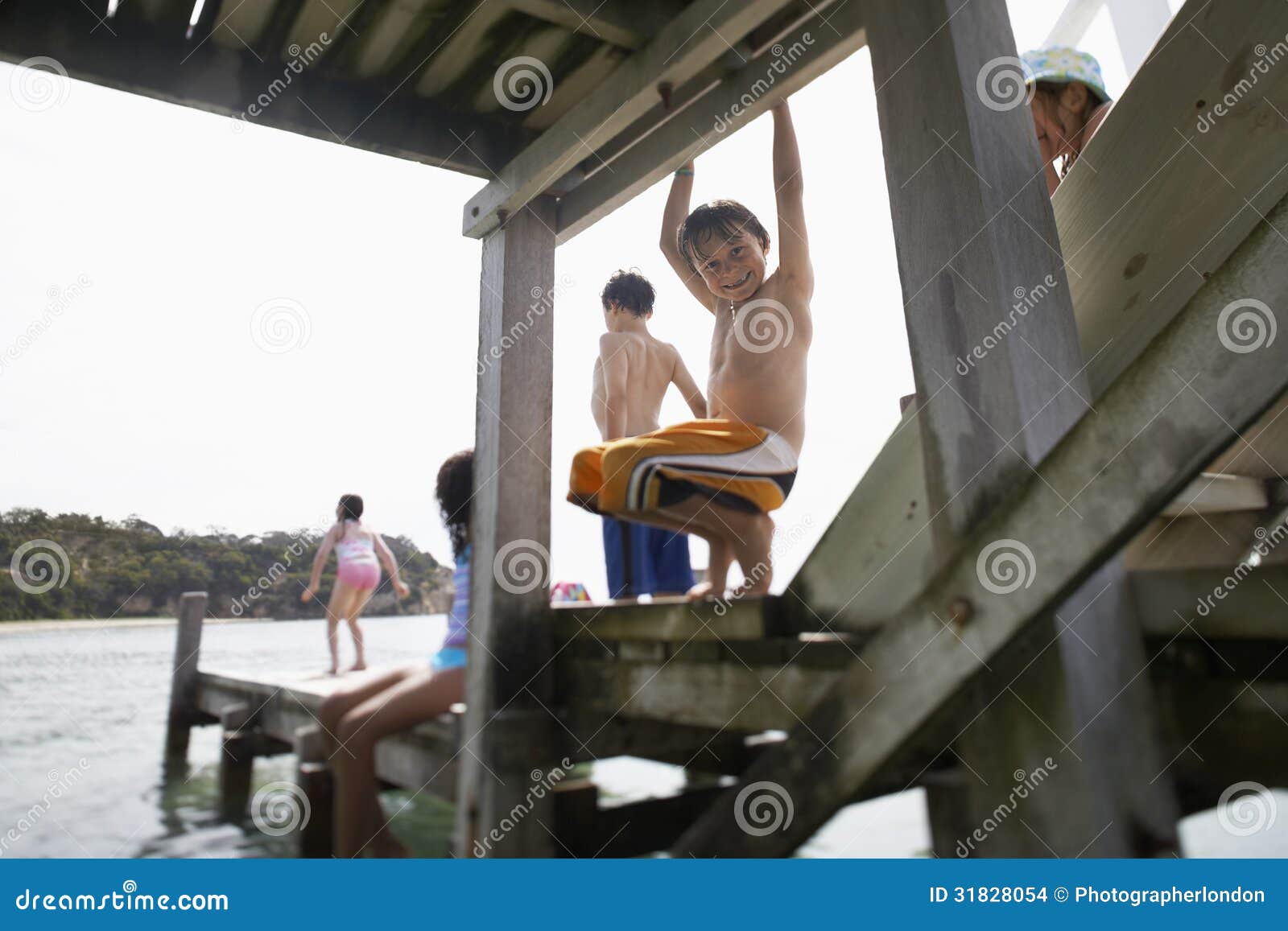 Happy Boy with Friends on Pier Stock Photo - Image of friend, focus ...