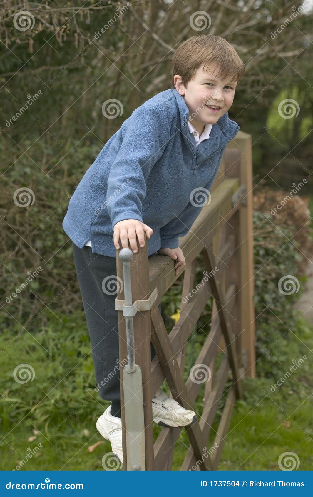 Happy boy on a gate stock photo. Image of active, infant - 1737504