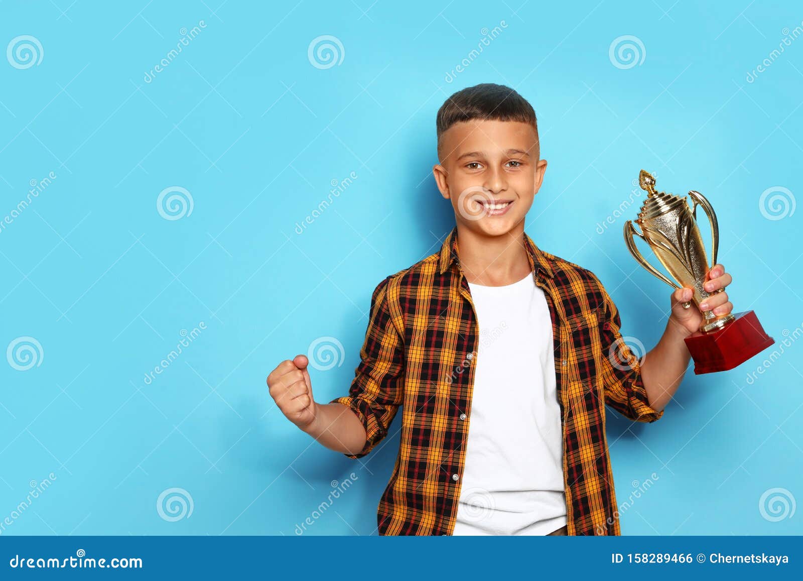 Happy Boy with Winning Cup on Blue Background Stock Photo - Image of ...