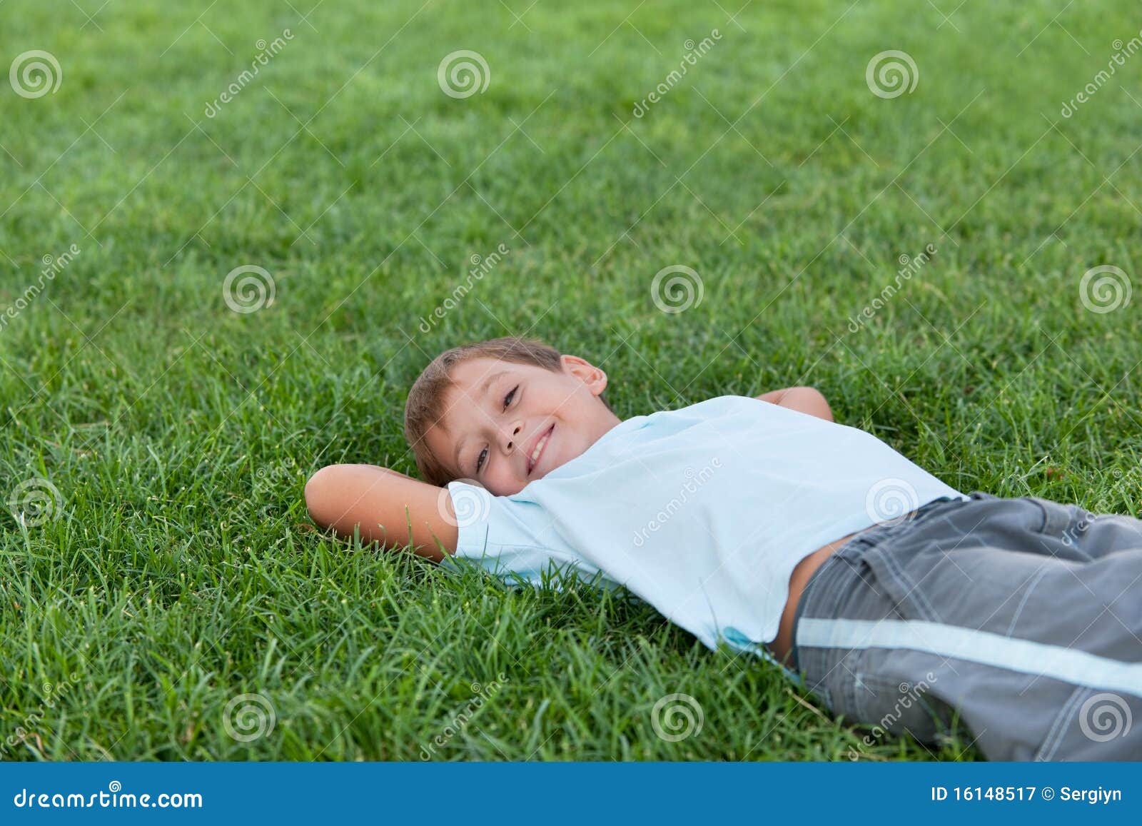 Happy Boy on the Green Grass Stock Image - Image of blue, arms: 16148517
