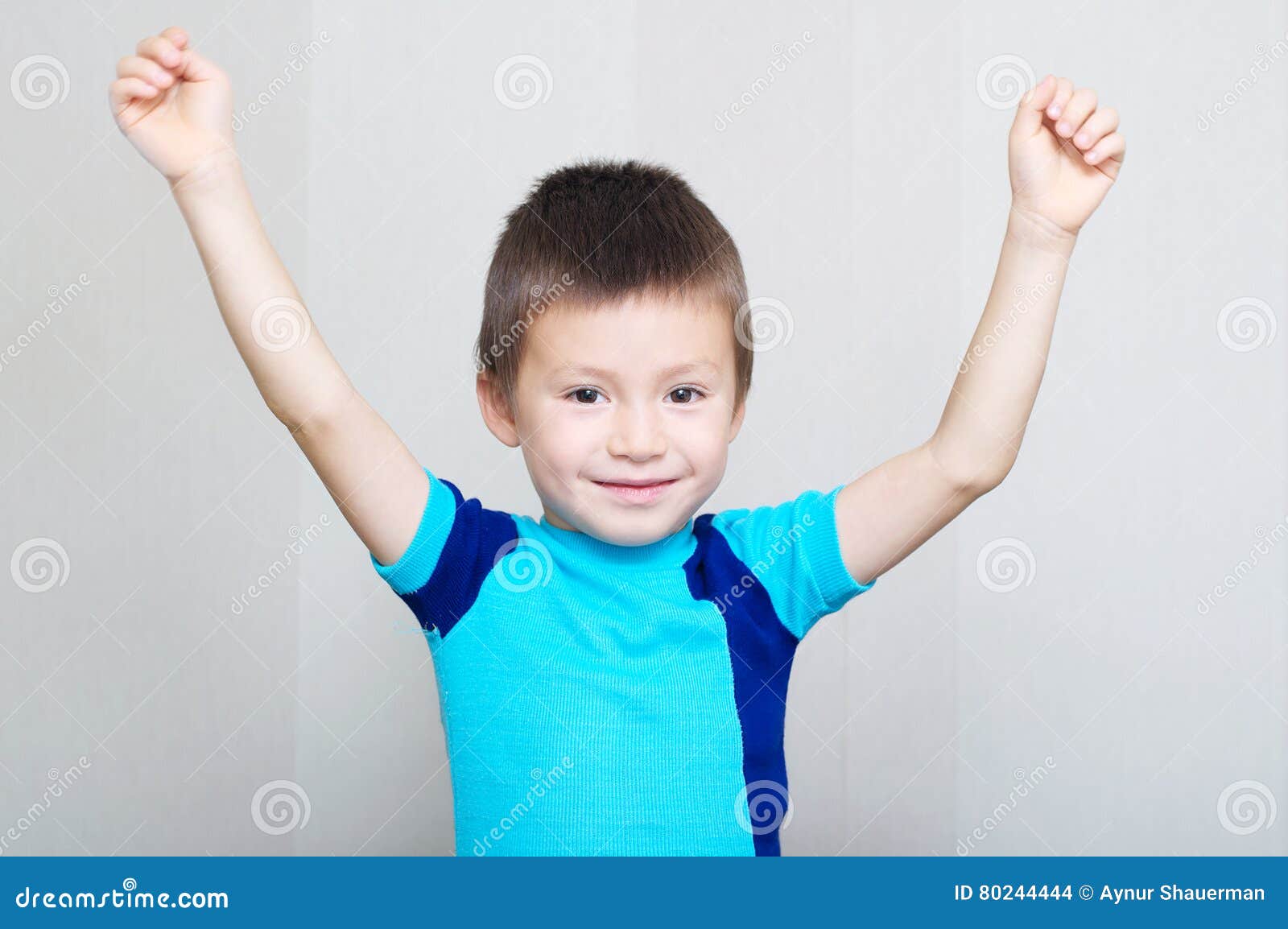 Happy boy with hands up stock photo. Image of joyful - 80244444