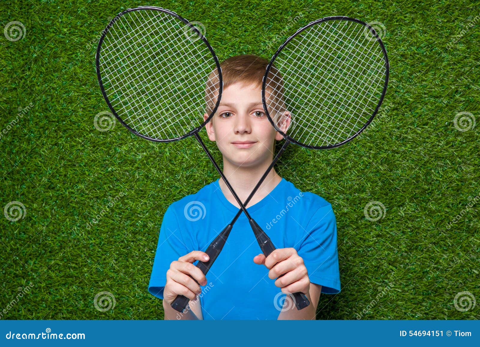 Happy Boy Holding Badminton Rackets Over Grass Stock Image - Image of ...