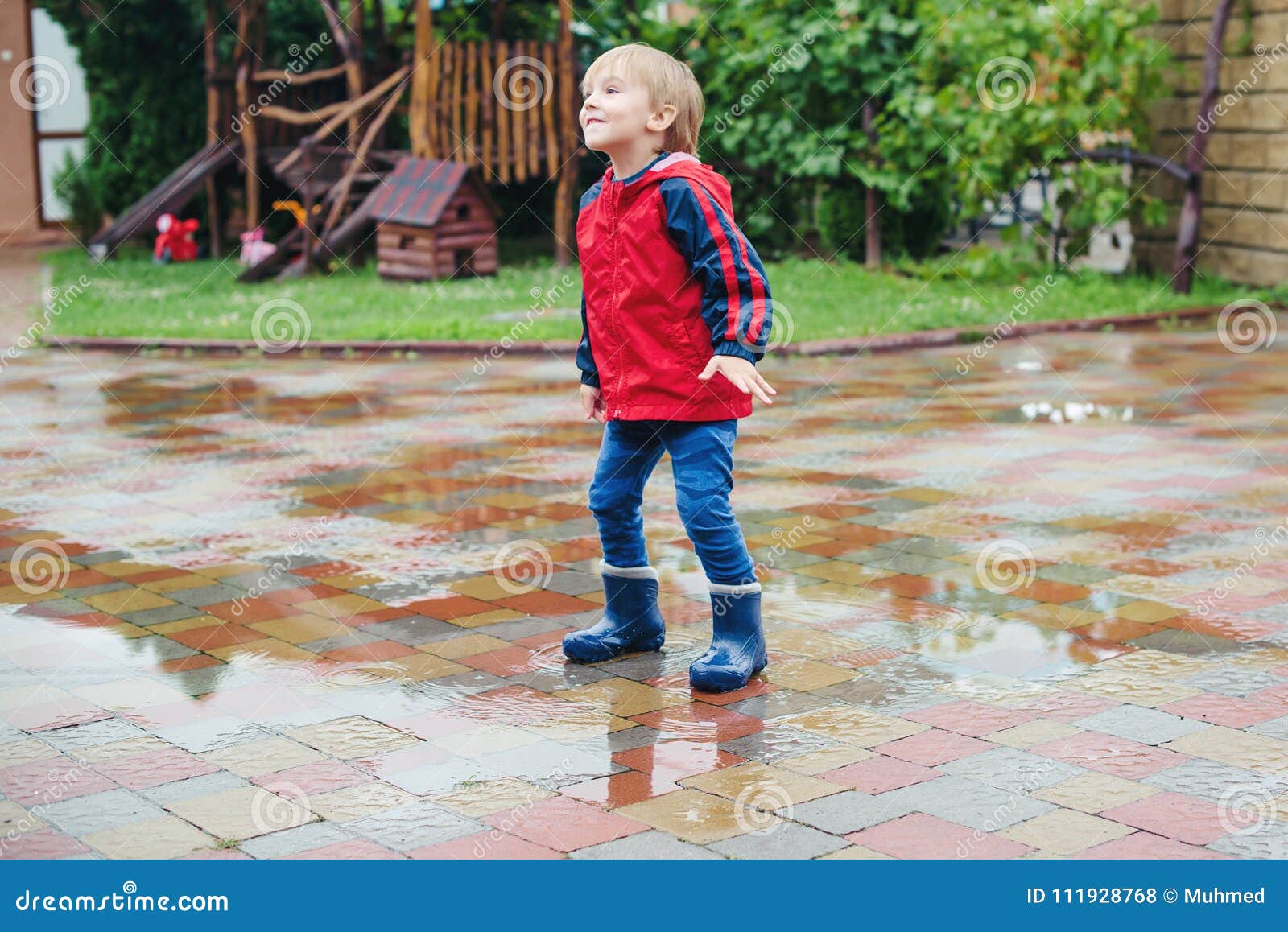 Happy Boy Jumping in Puddles after Rain. Stock Photo - Image of ...